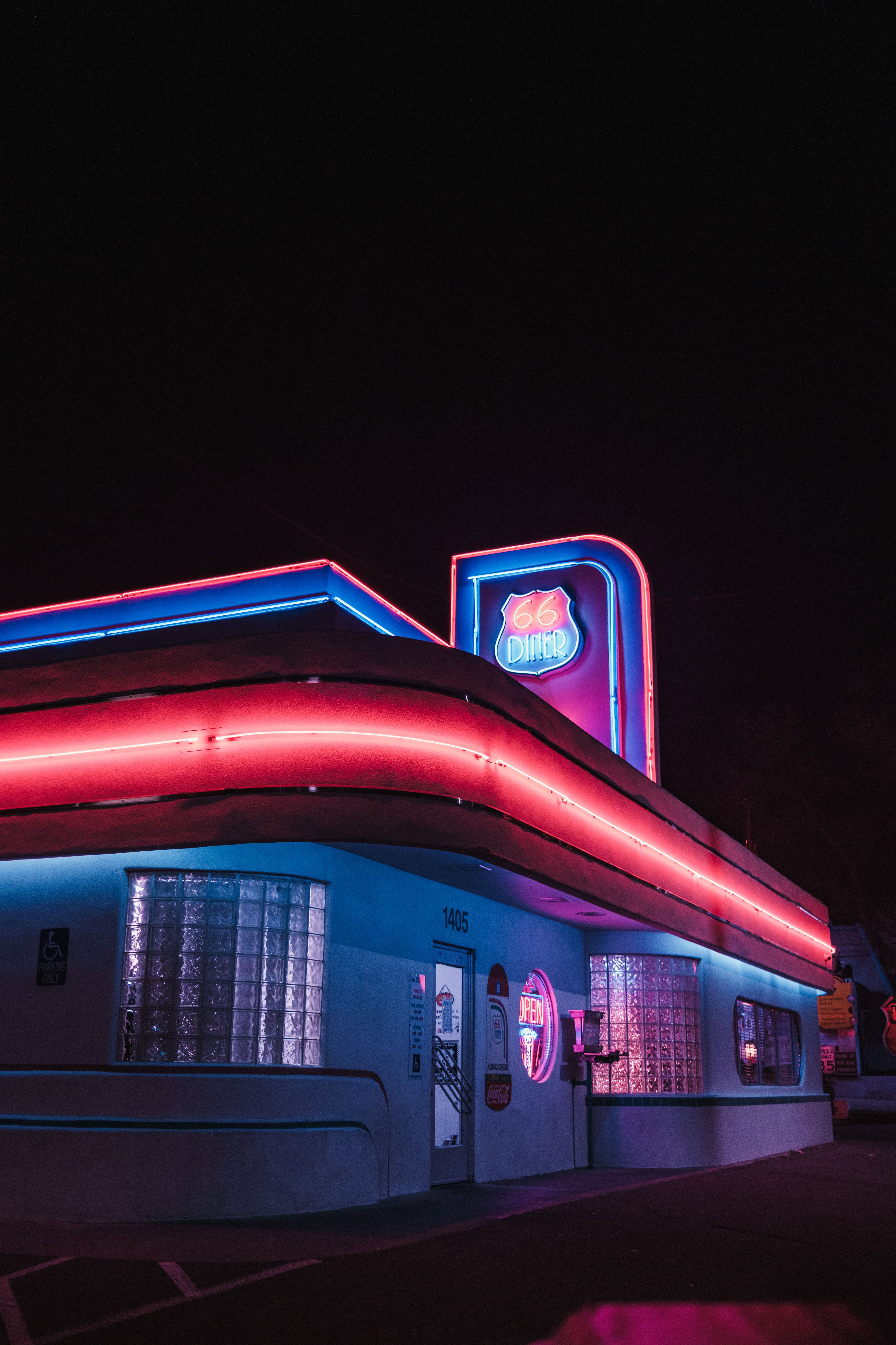 Fast food restaurant and famous road sign against overcast evening sky ...