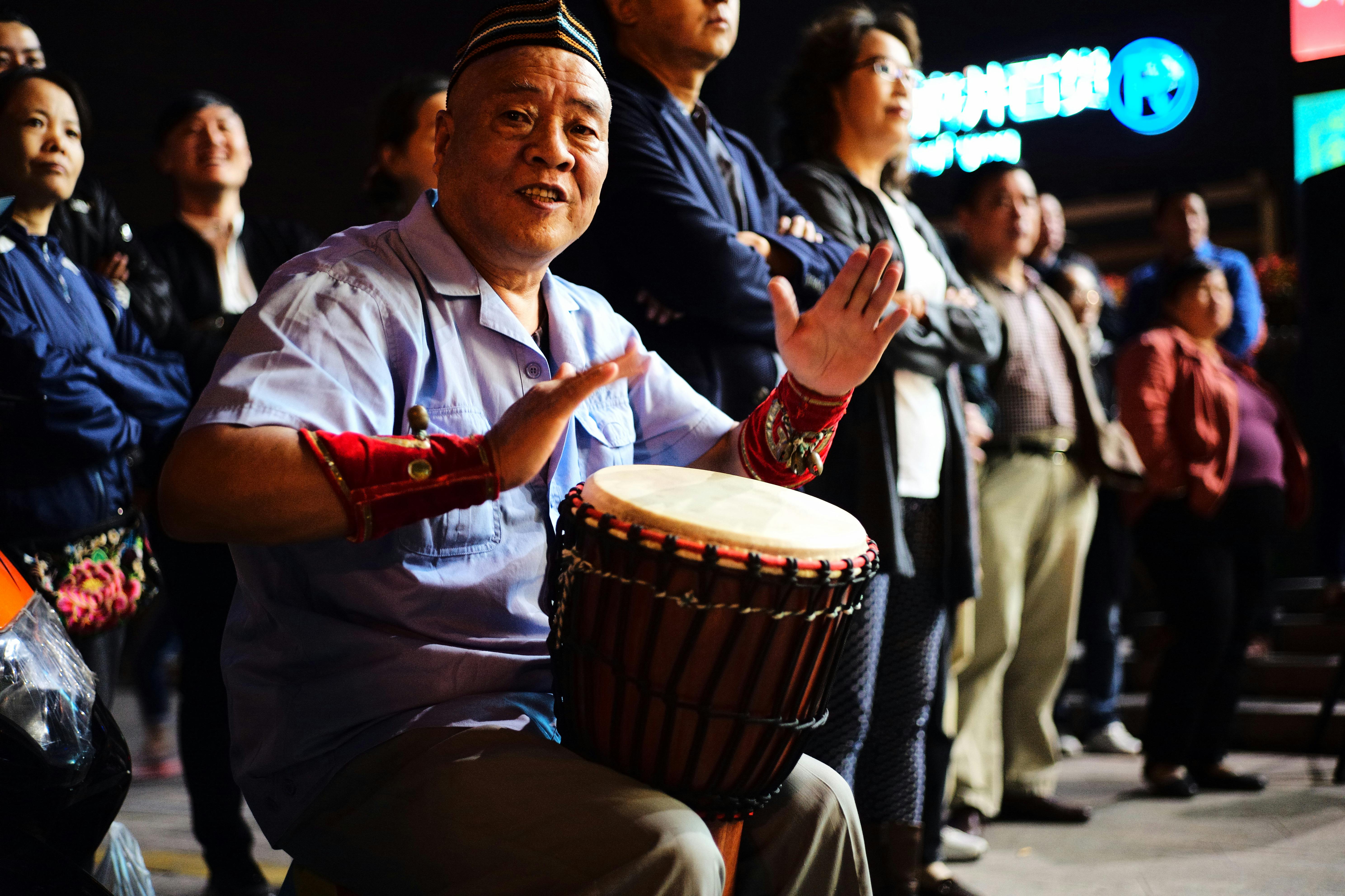 A man playing a drum in front of a crowd · Free Stock Photo