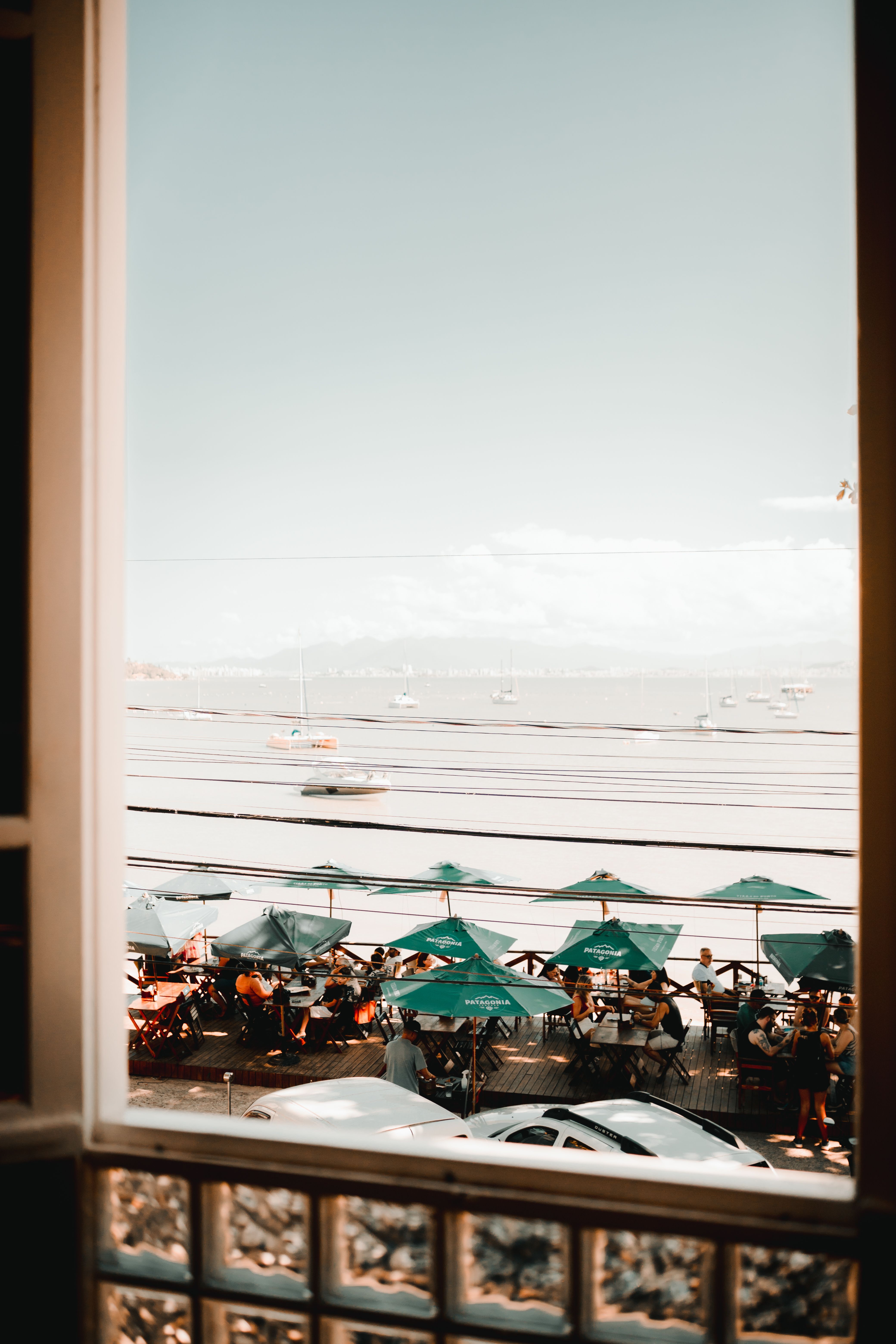White Patio Table Set Near Ocean · Free Stock Photo