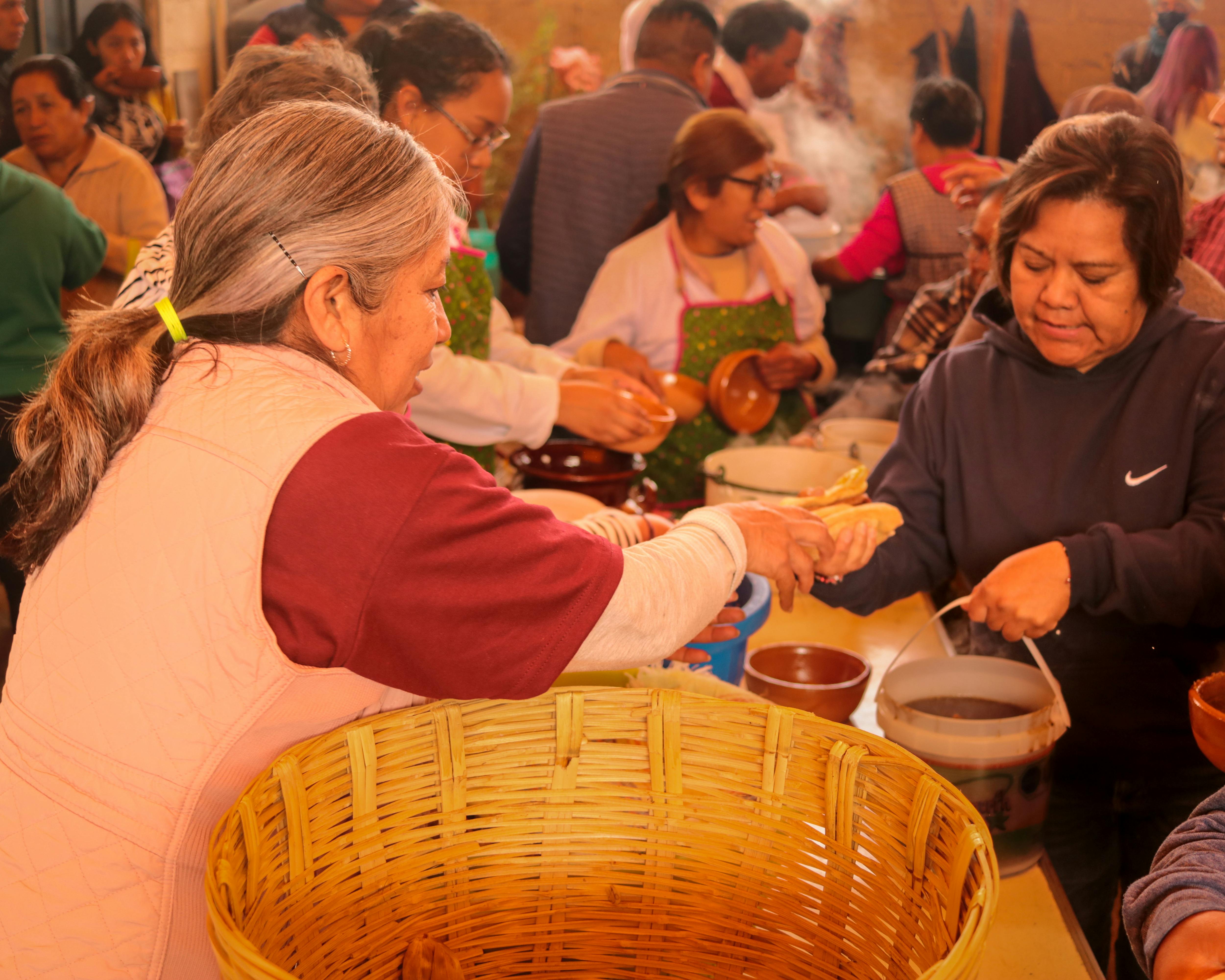 Woman Handing Out Bread · Free Stock Photo