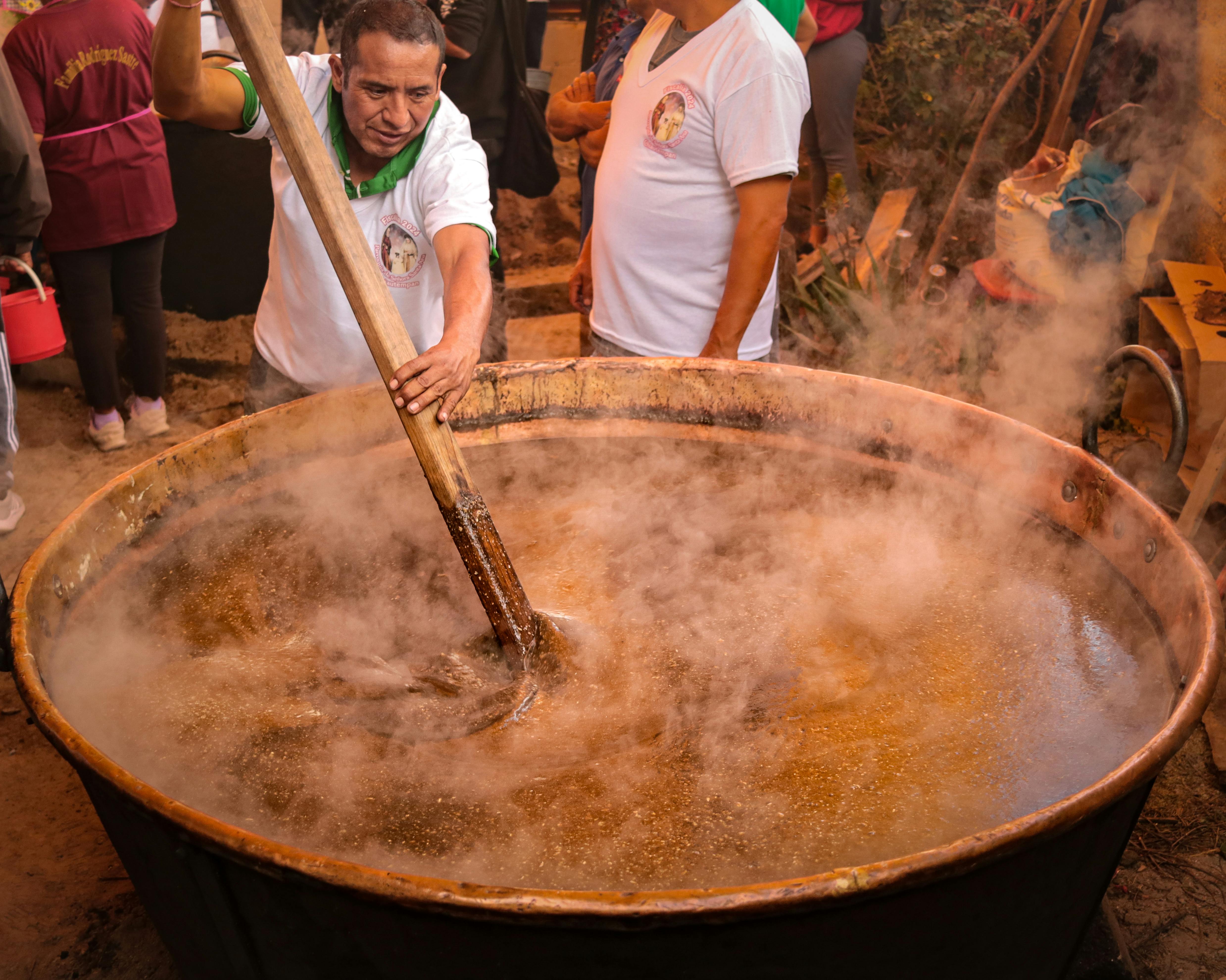 Man Melting Liquid in Giant Pot · Free Stock Photo