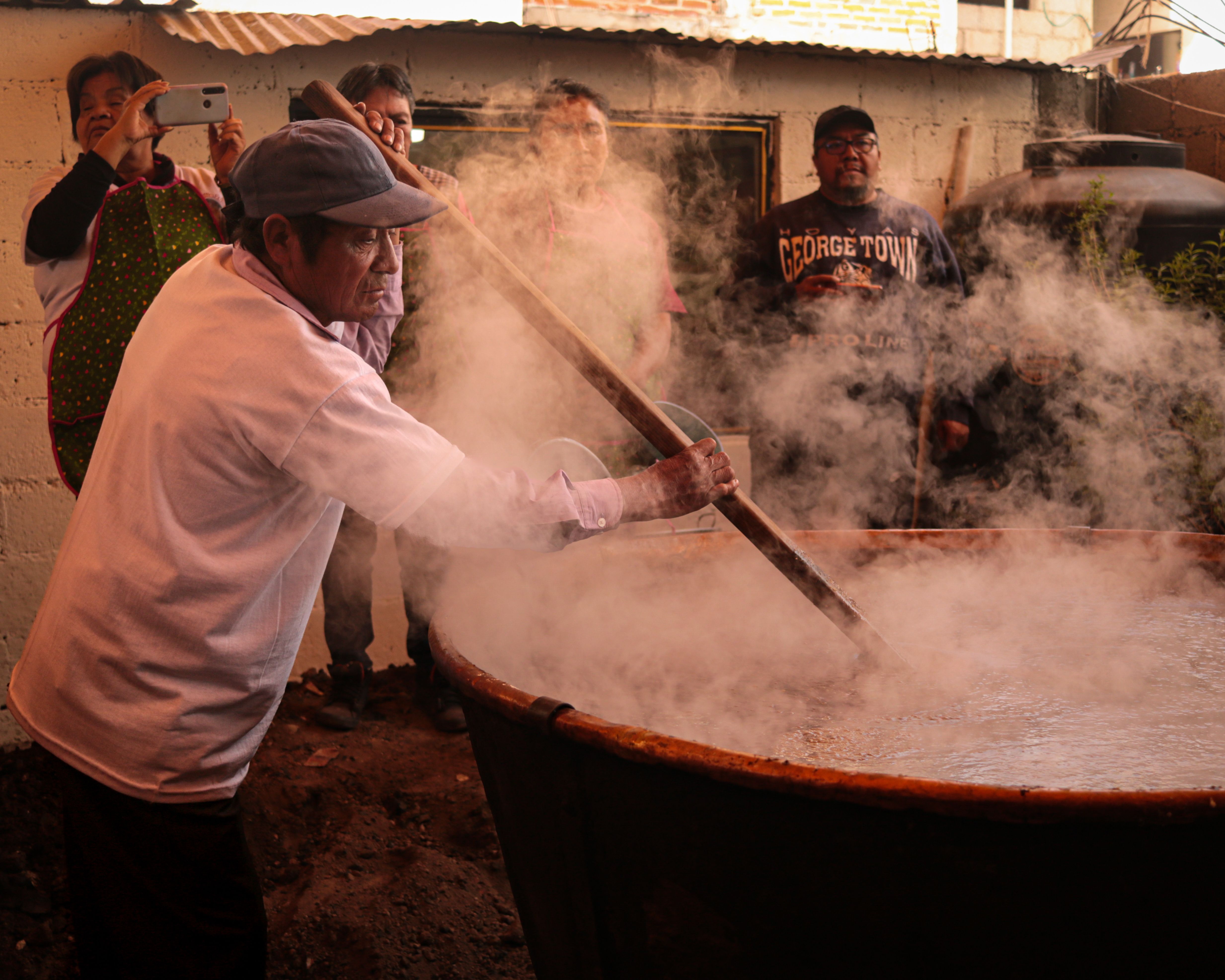 Cook Stirring Soup in a Huge Cauldron · Free Stock Photo