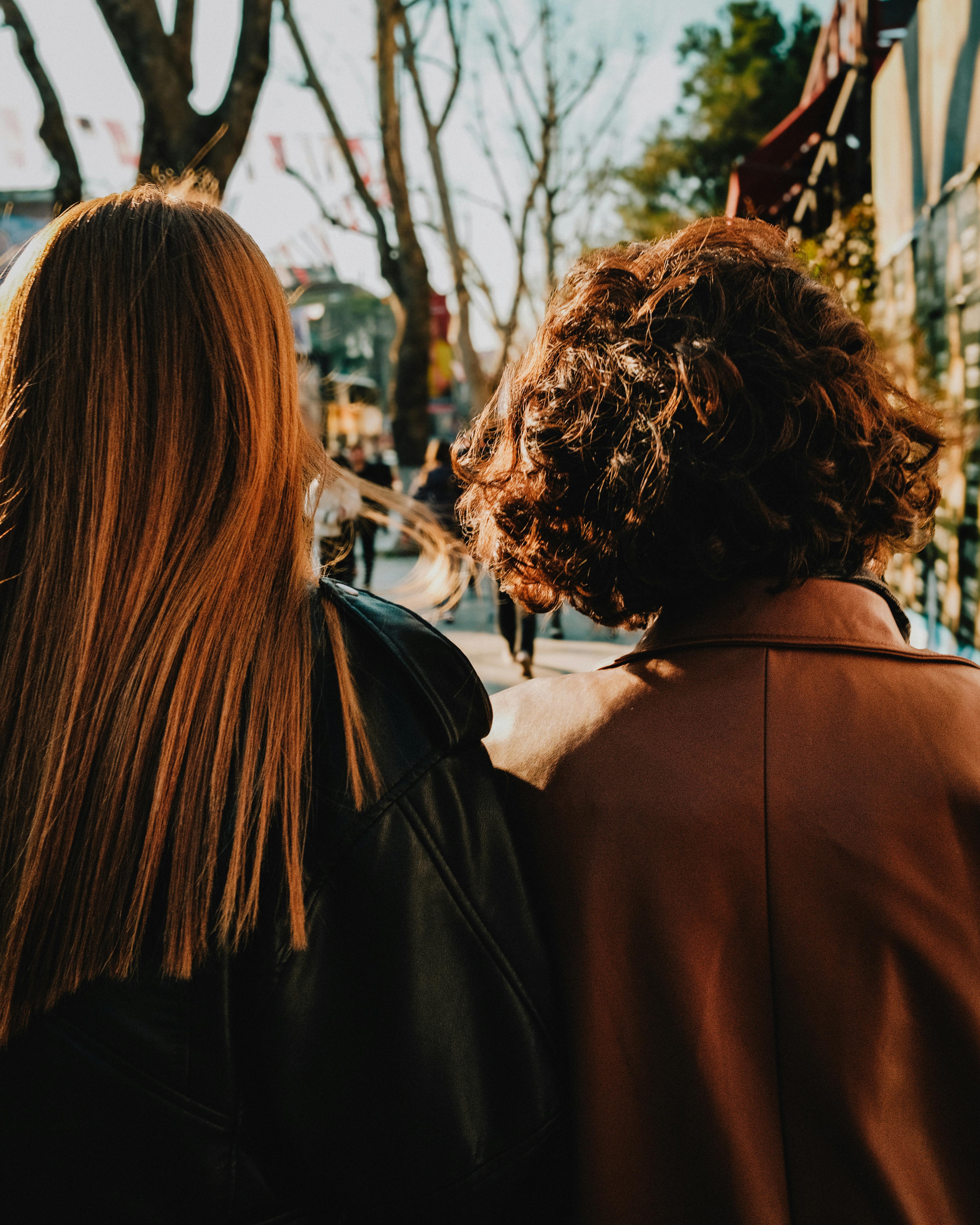 Friends in Leather Jackets Walking Arm in Arm Down the Sidewalk · Free ...