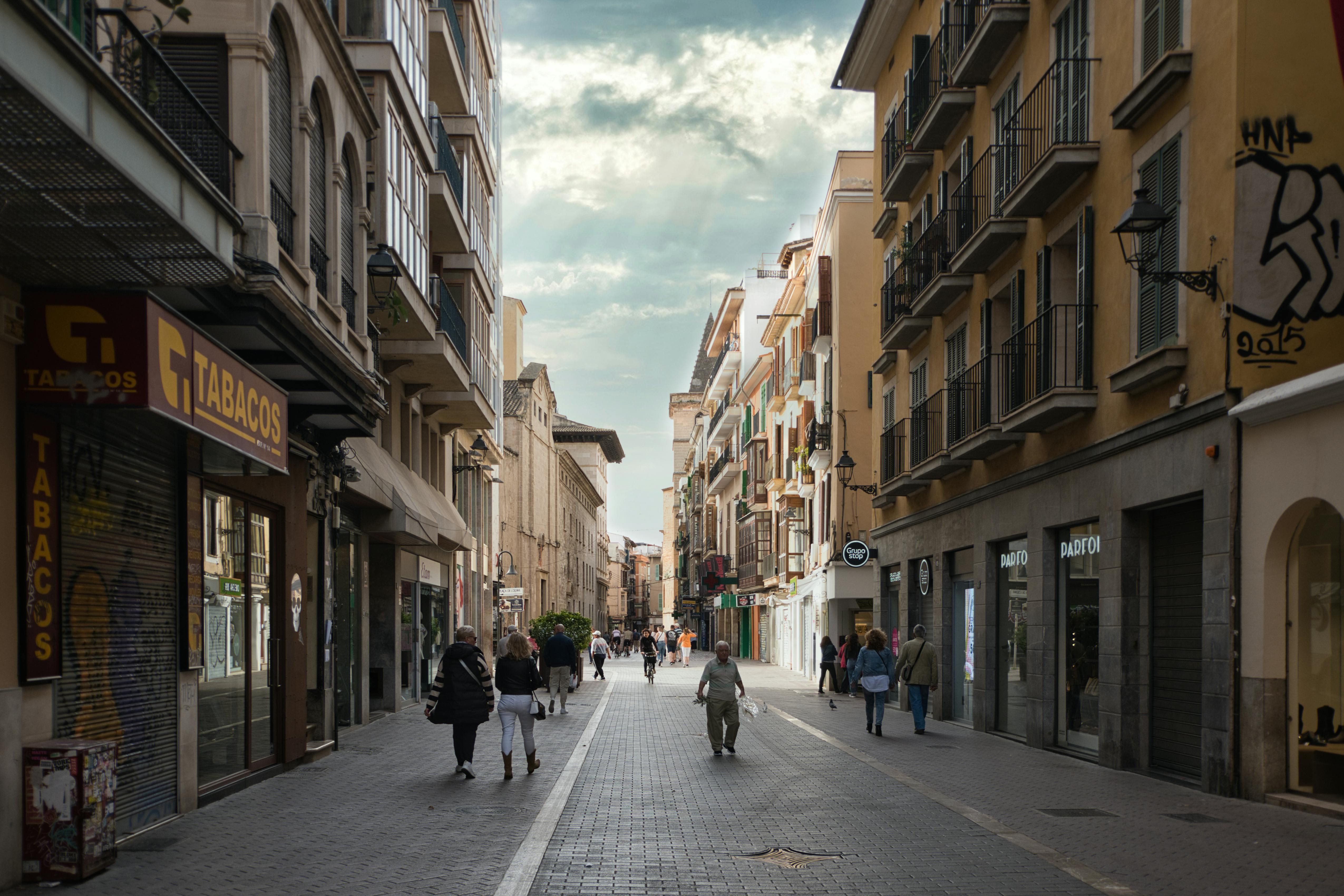 Pavement Street with Store Fronts and People Walking · Free Stock Photo