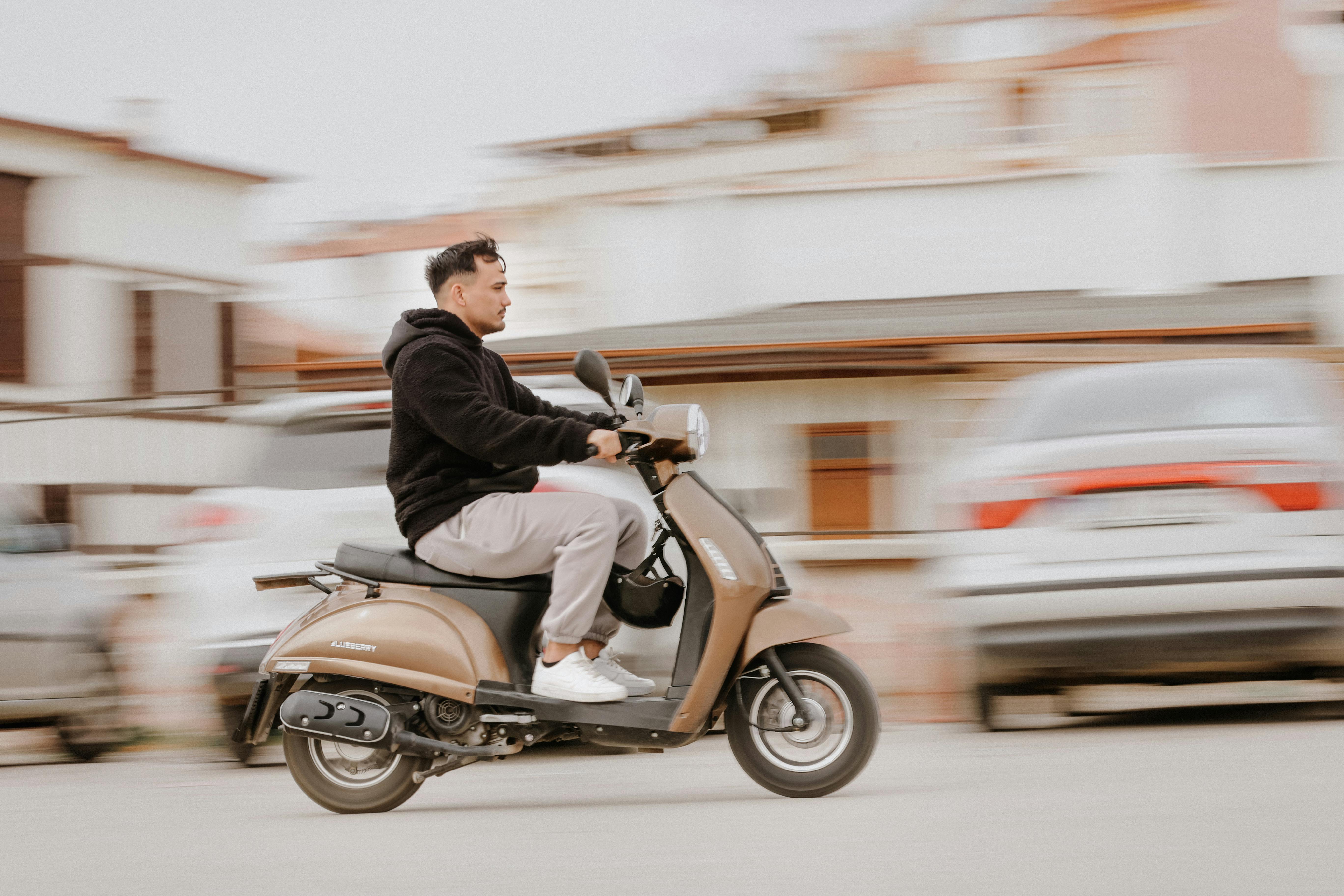 Man Riding Motor Scooter · Free Stock Photo