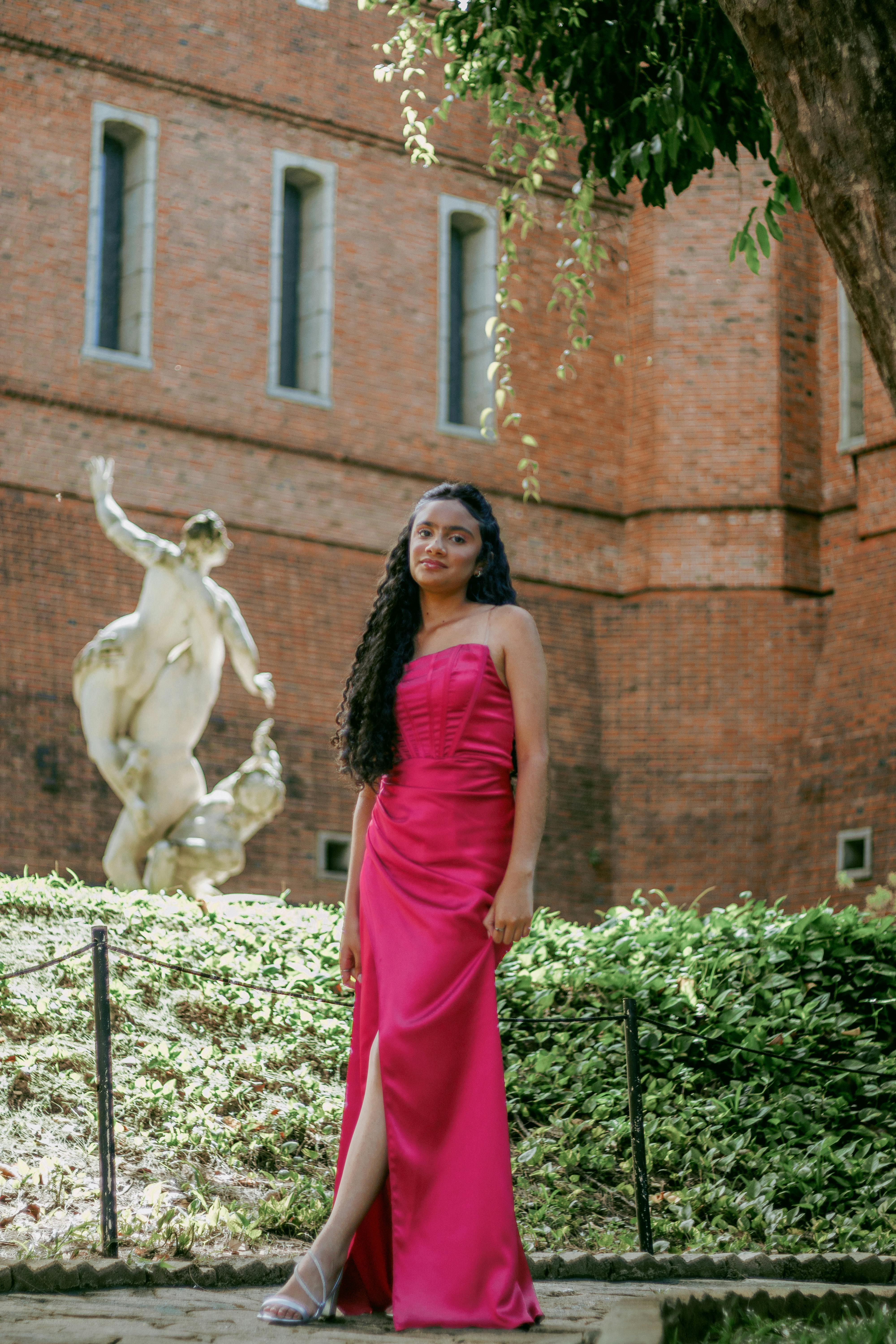 A woman in a pink dress poses for a photo · Free Stock Photo