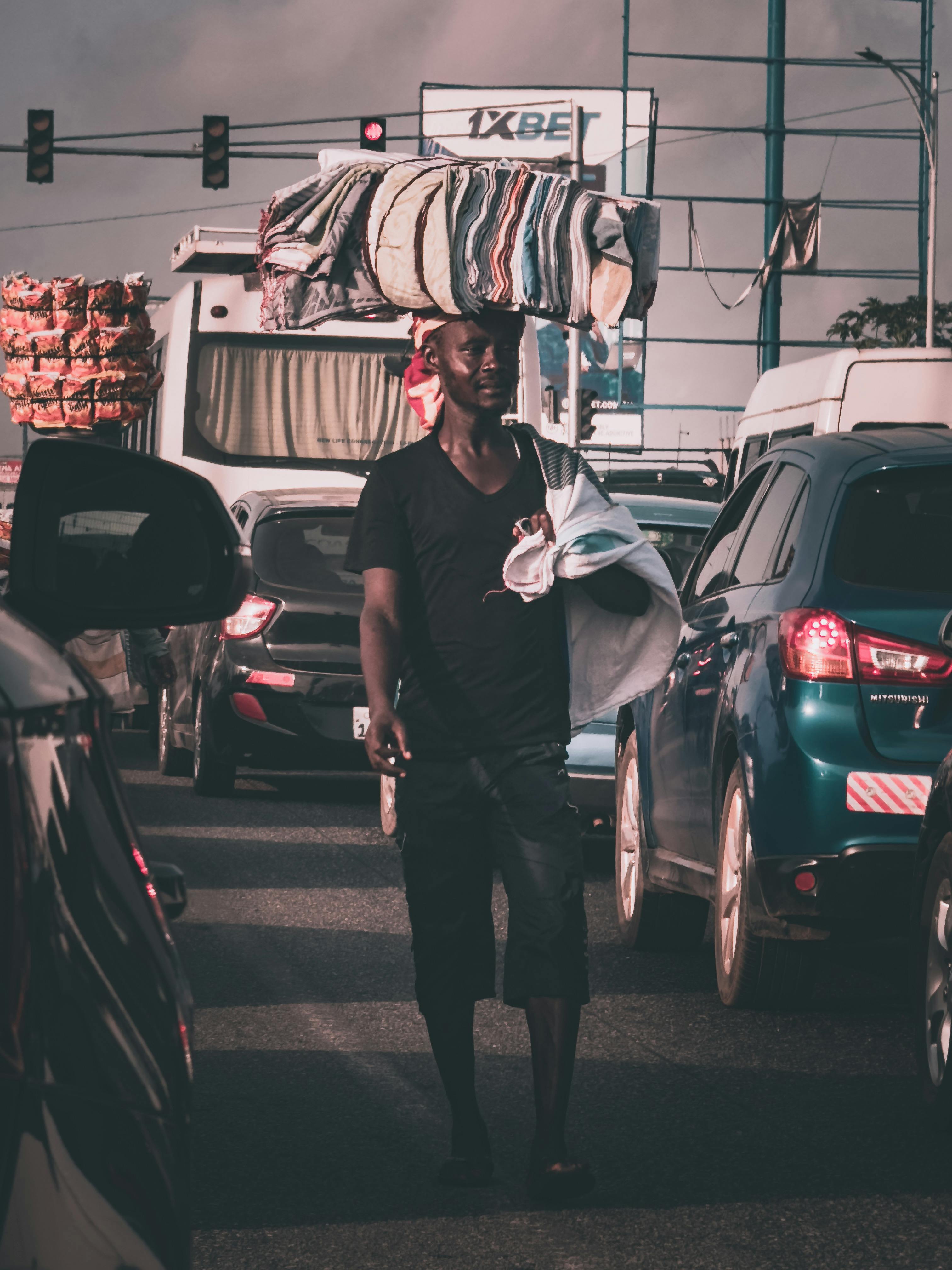 Peddler in the Middle of a Busy Road · Free Stock Photo