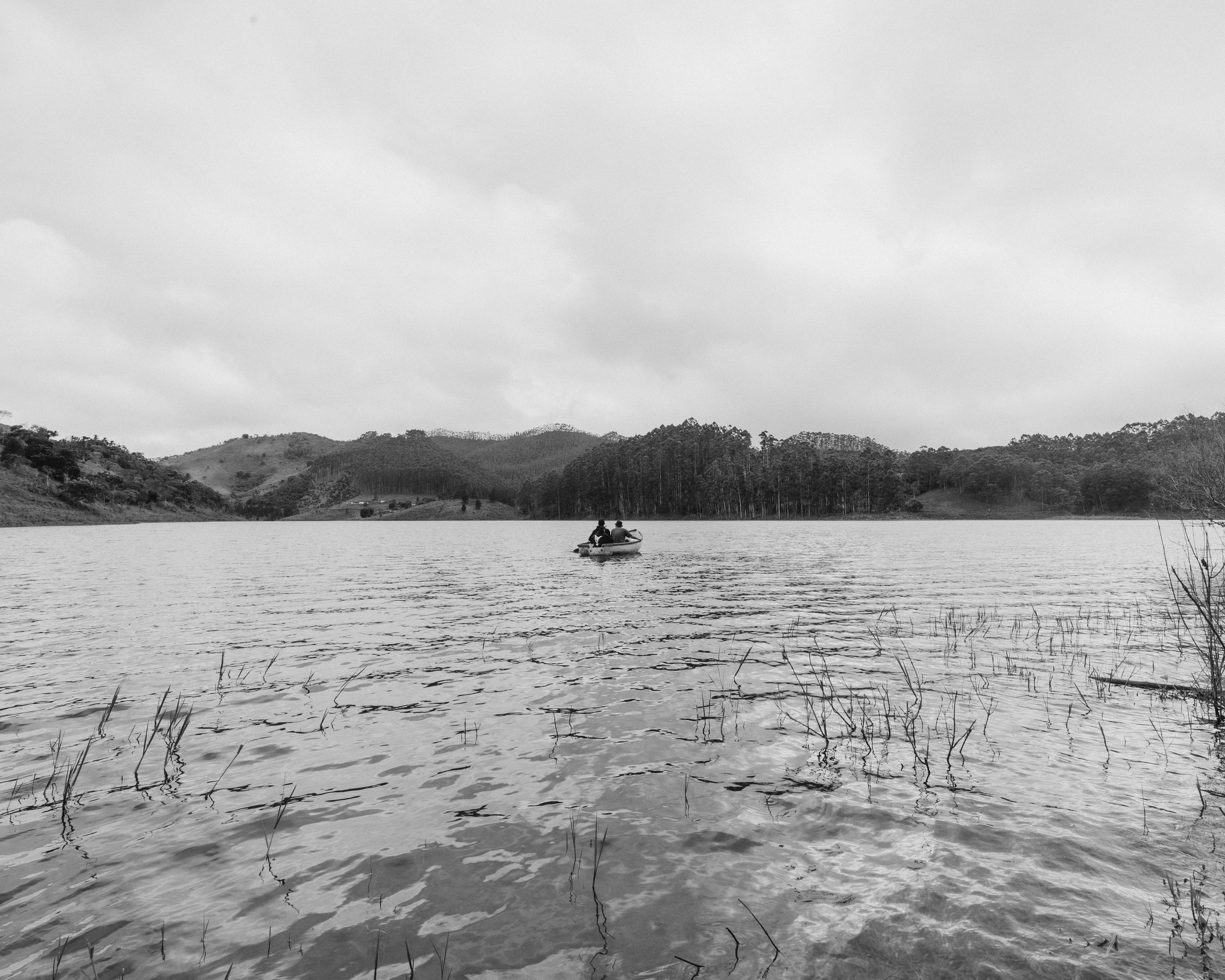 People Crossing a Lake in a Boat · Free Stock Photo