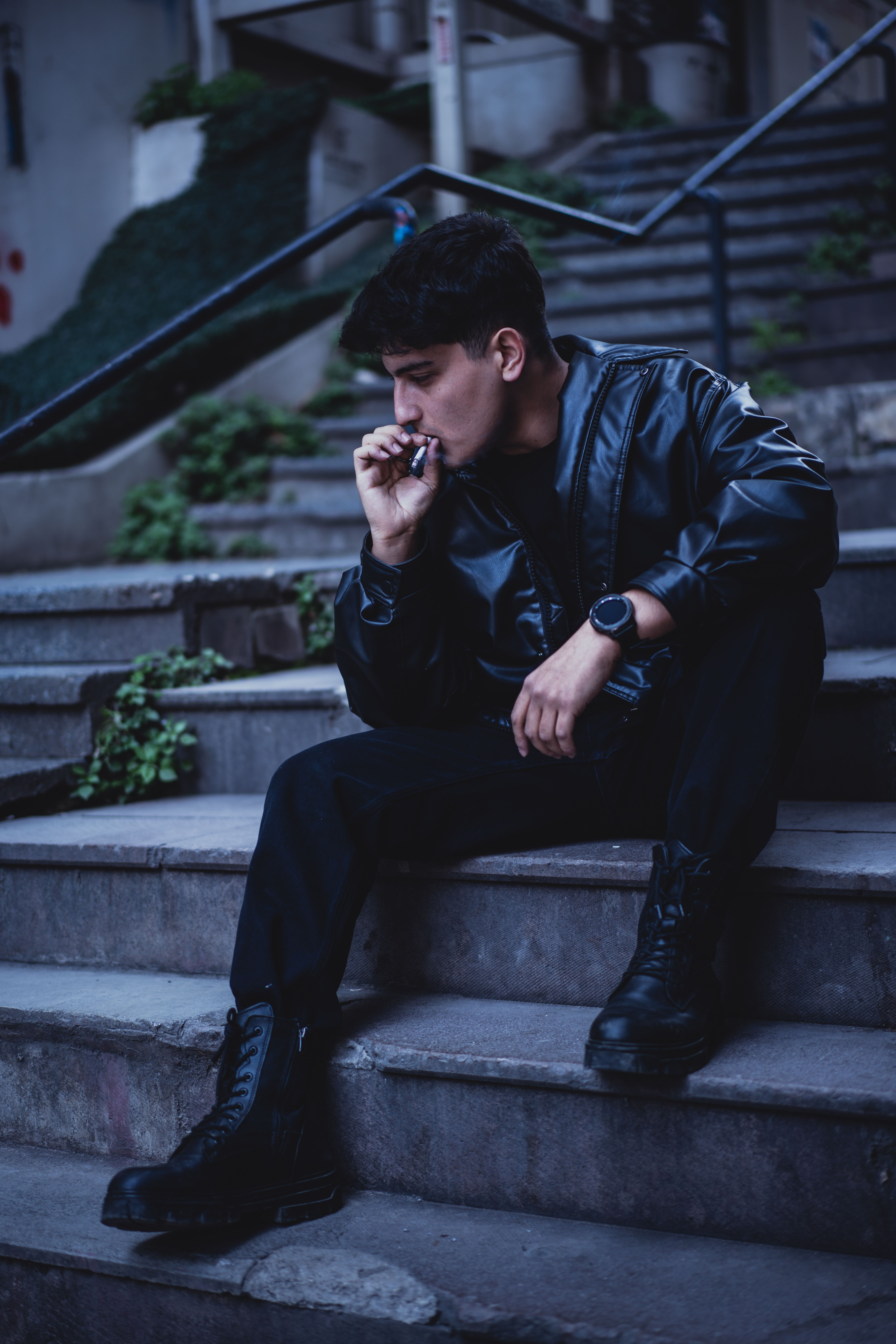 Man in Leather Jacket Sitting on Stairs and Smoking Cigarette · Free ...