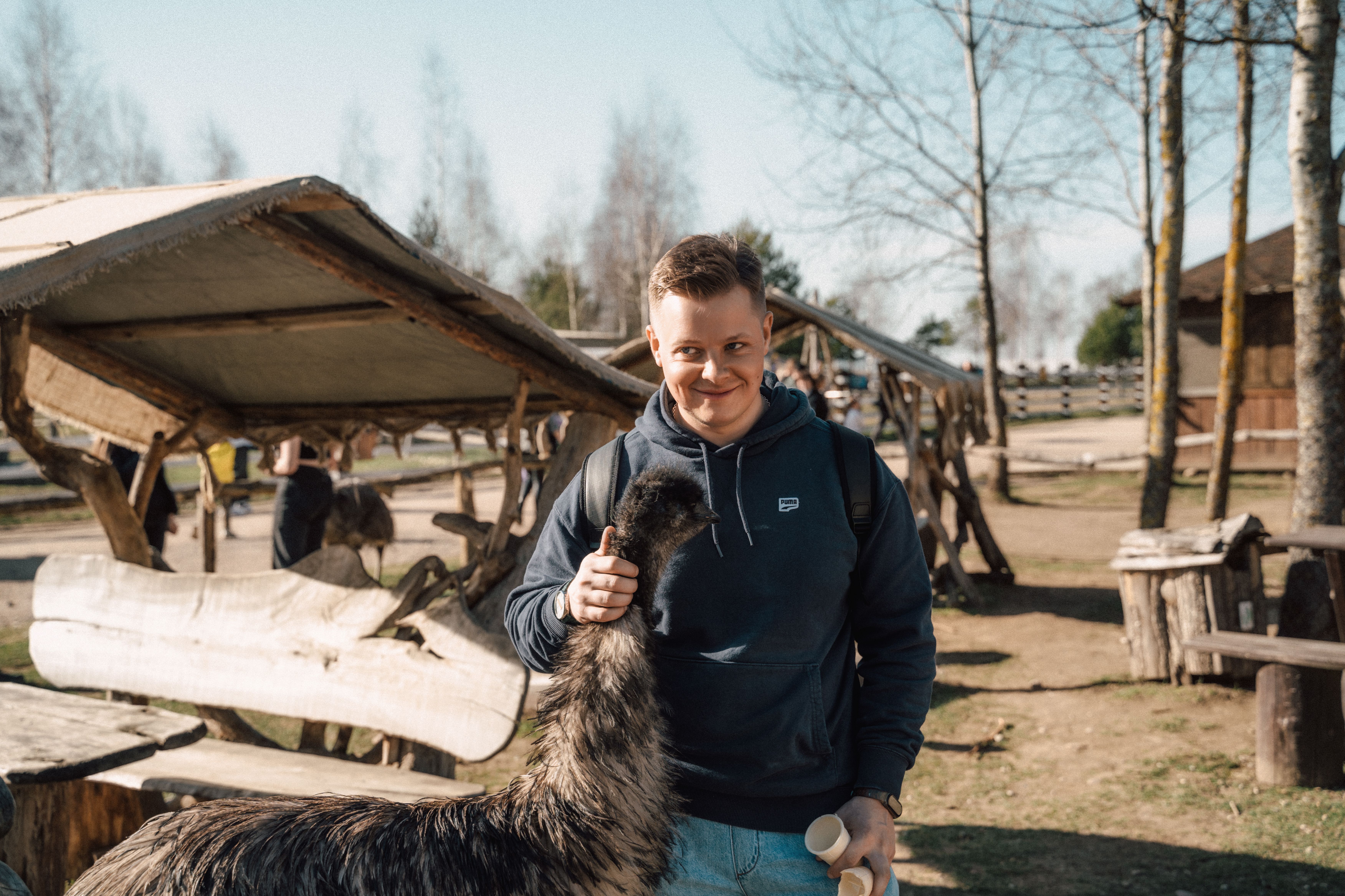 Smiling Man with an Ostrich · Free Stock Photo