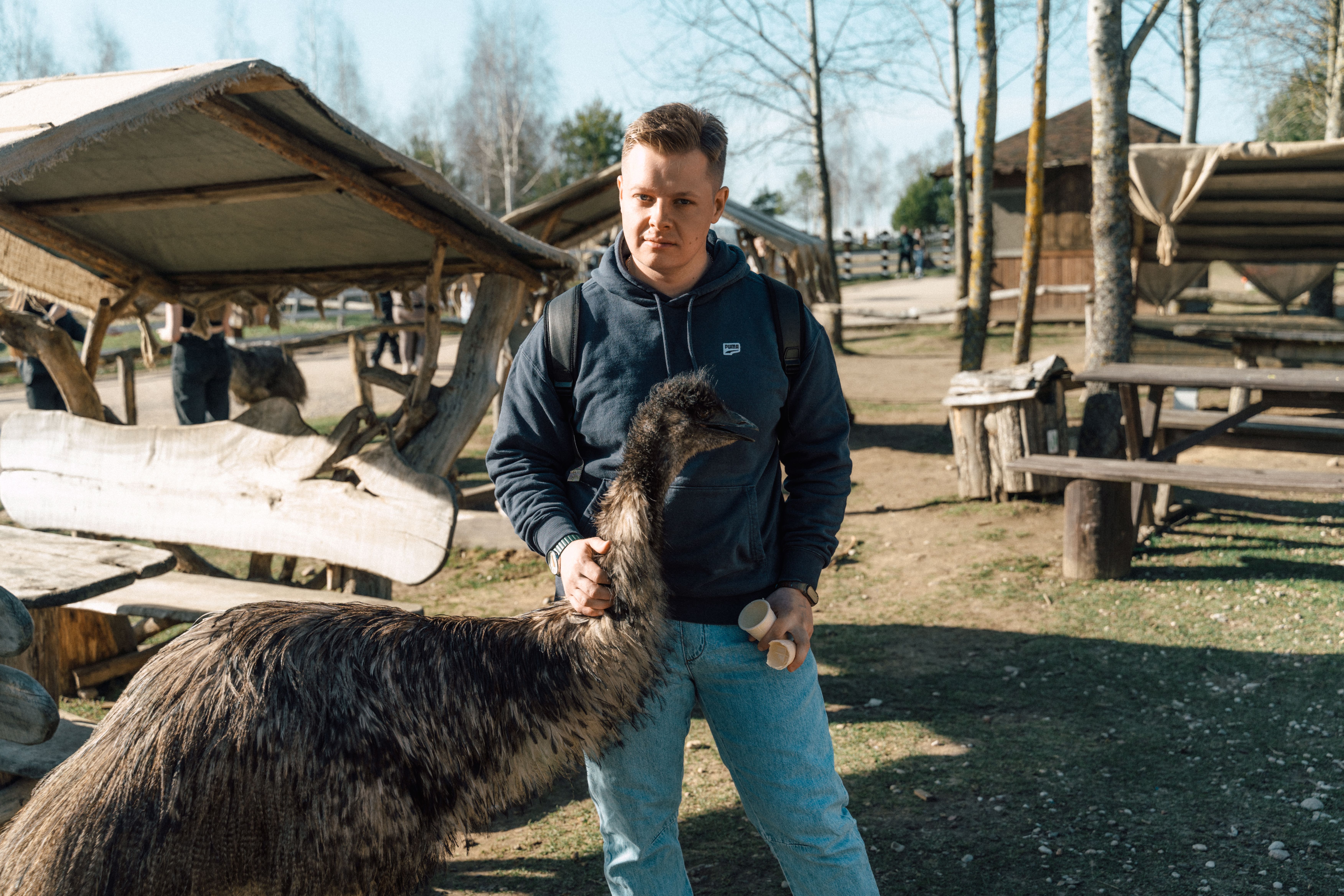 Photo of a Man Standing next to an Ostrich · Free Stock Photo