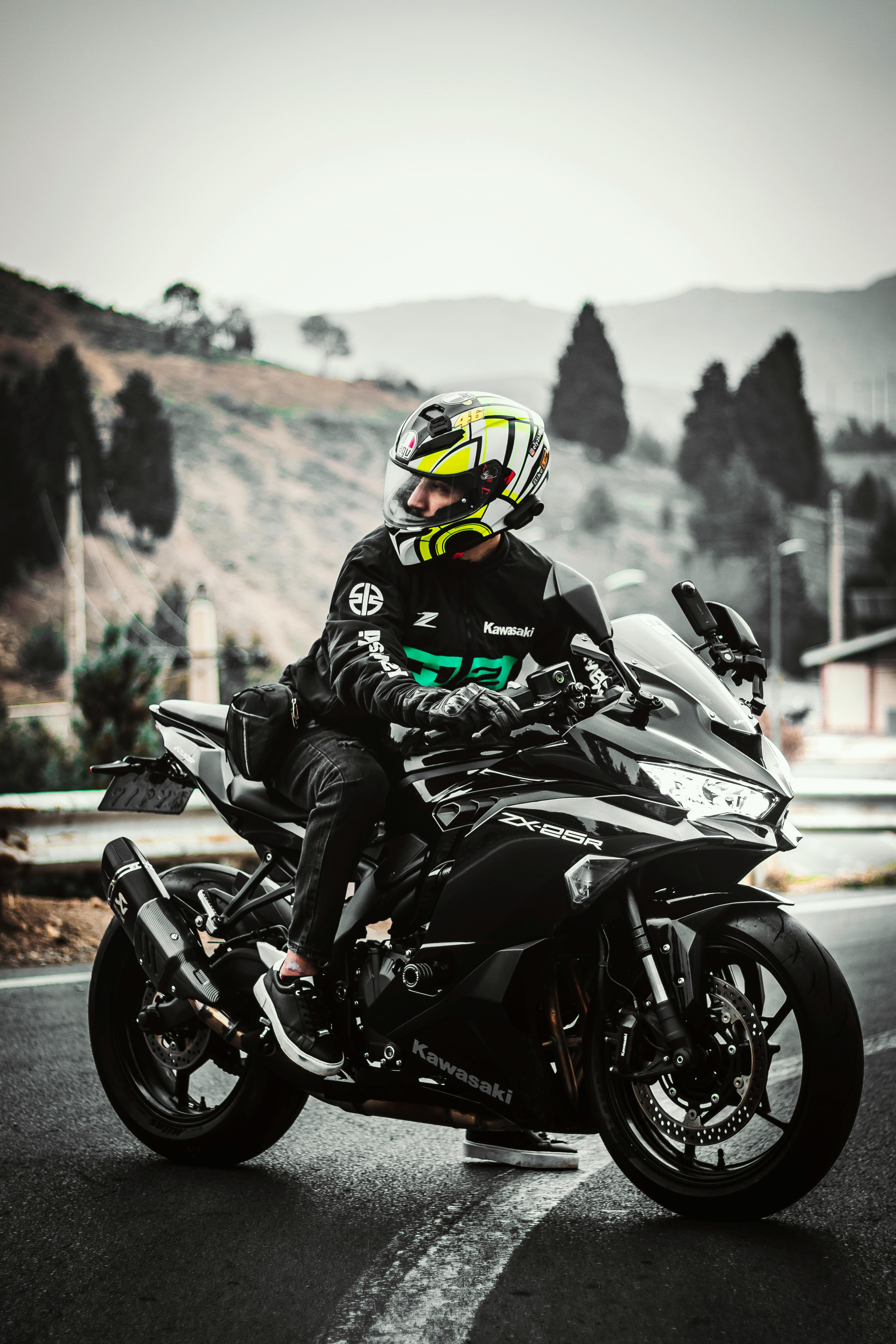 Photo of a Person with a Red Helmet Riding a Motorcycle · Free Stock Photo