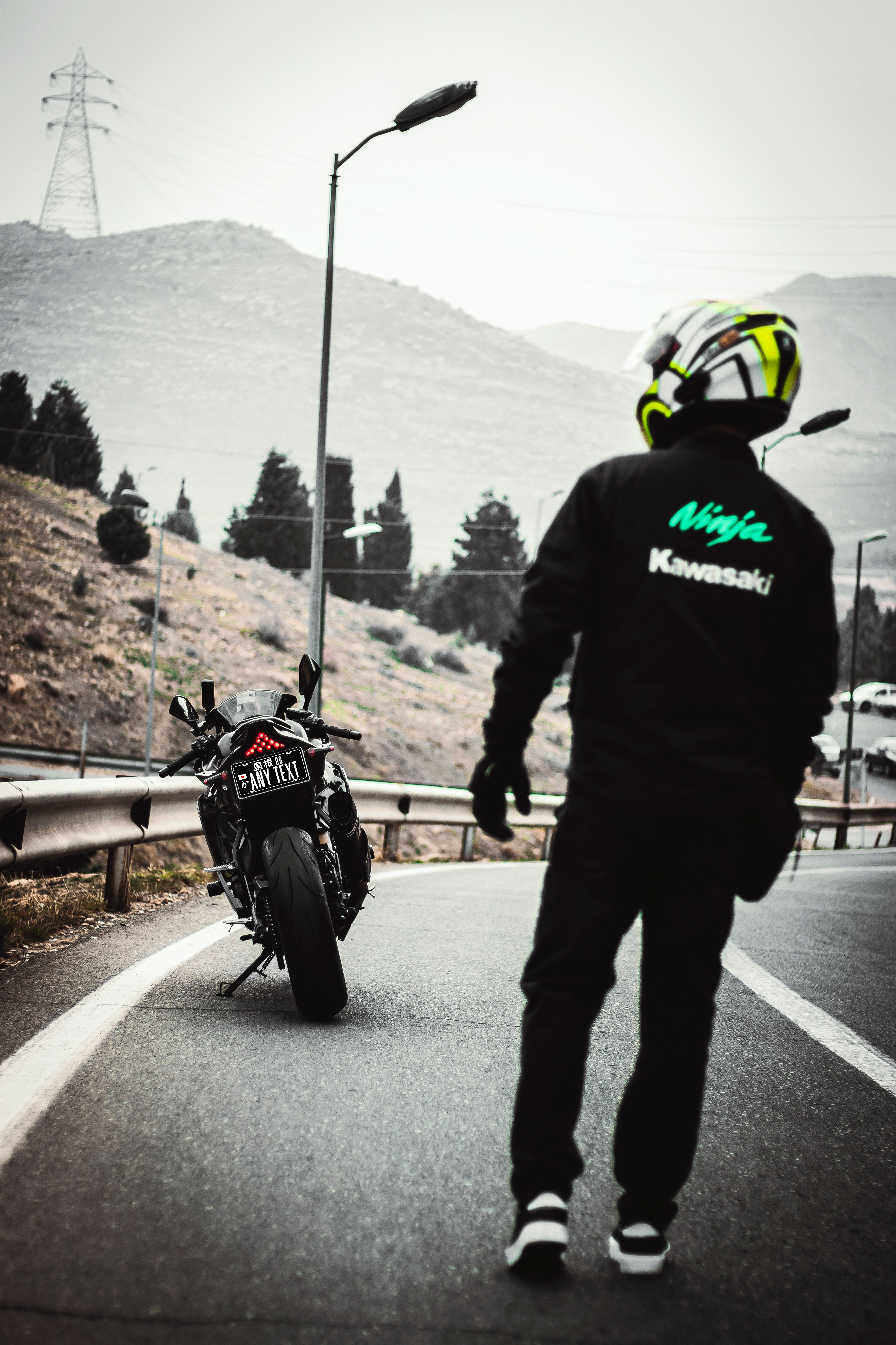 Man Walking towards Motorcycle Parked on Road · Free Stock Photo