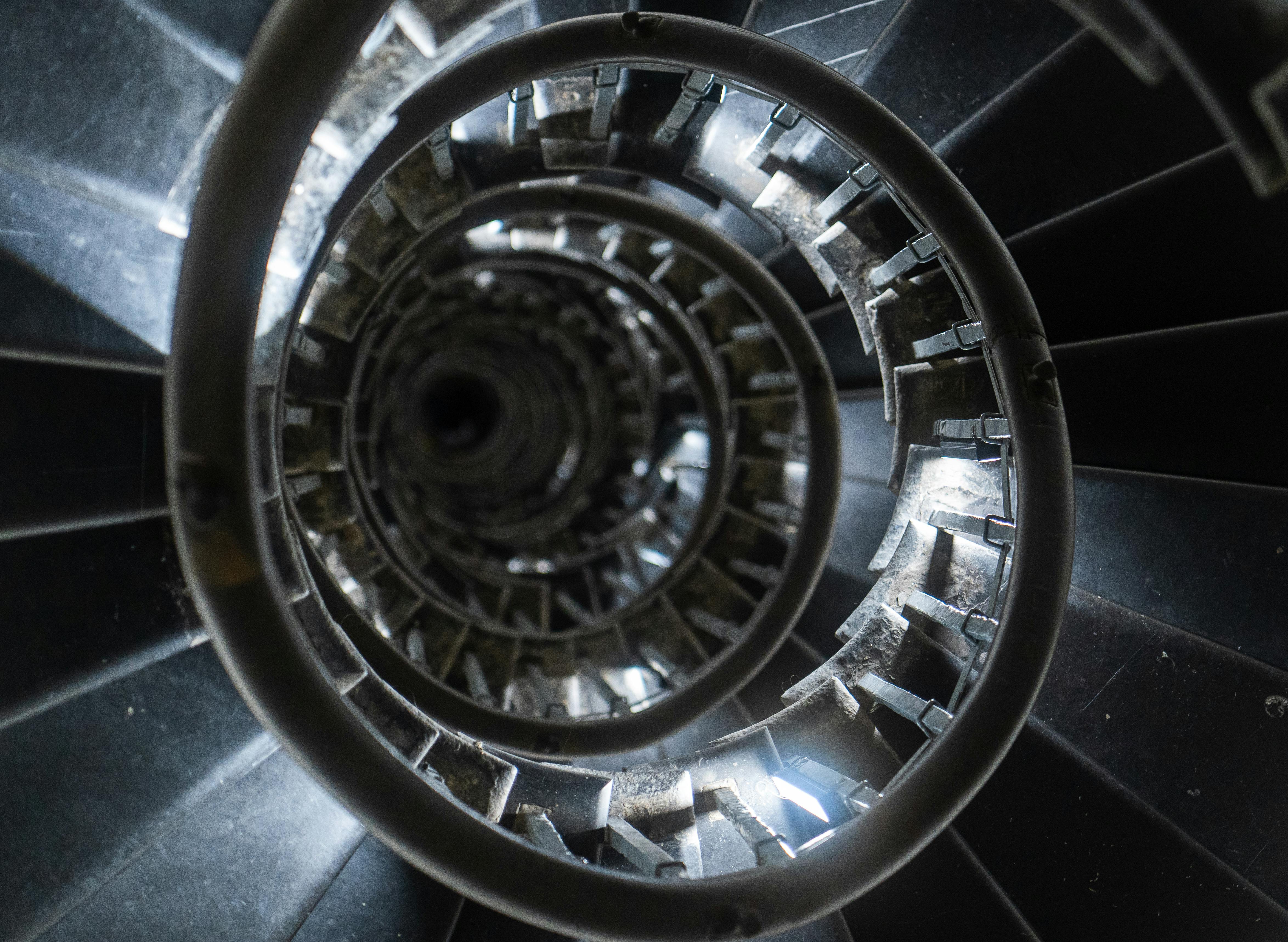 Dark Spiral Staircase Illuminated by Sunlight · Free Stock Photo