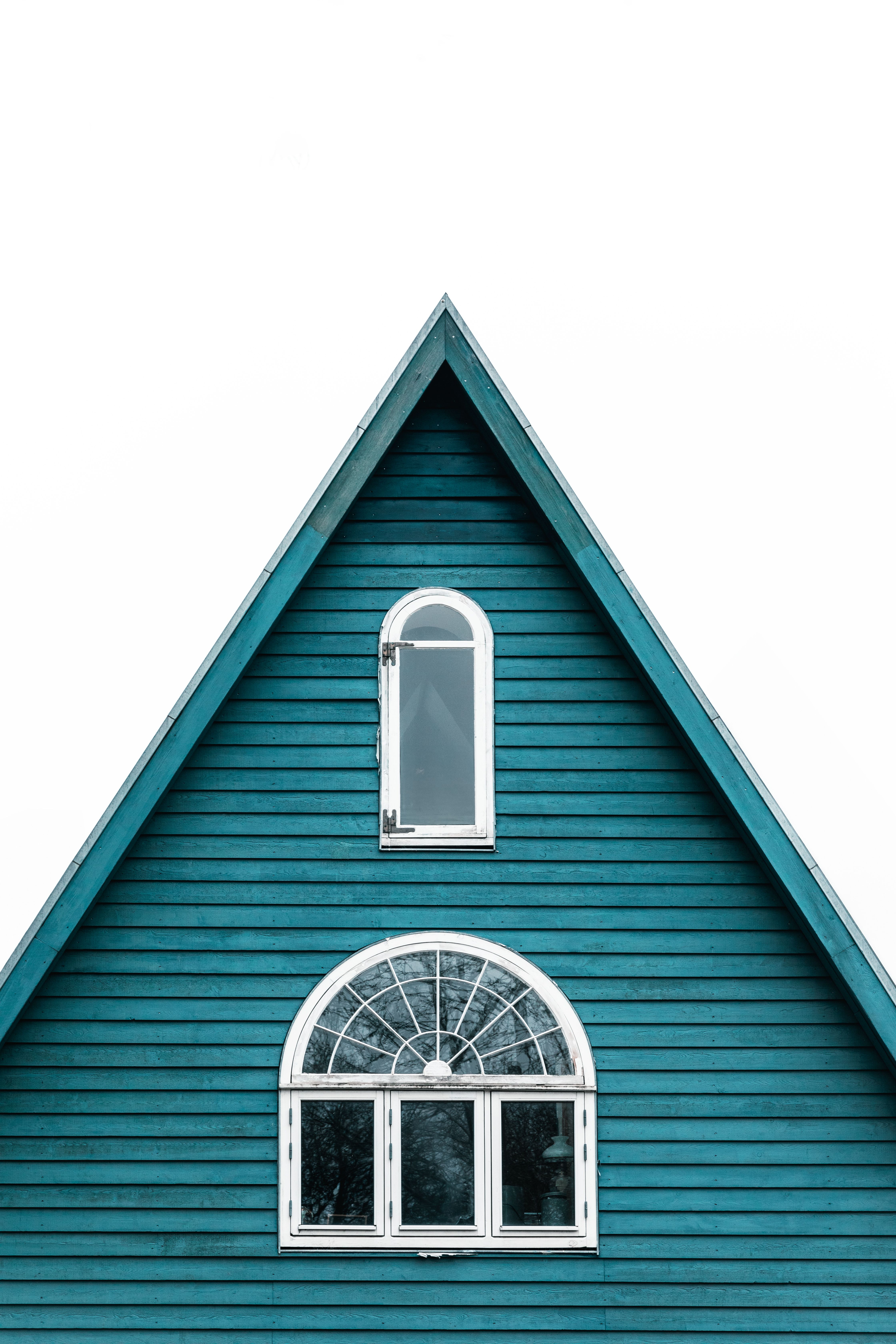 A blue house with a white window and a blue roof · Free Stock Photo