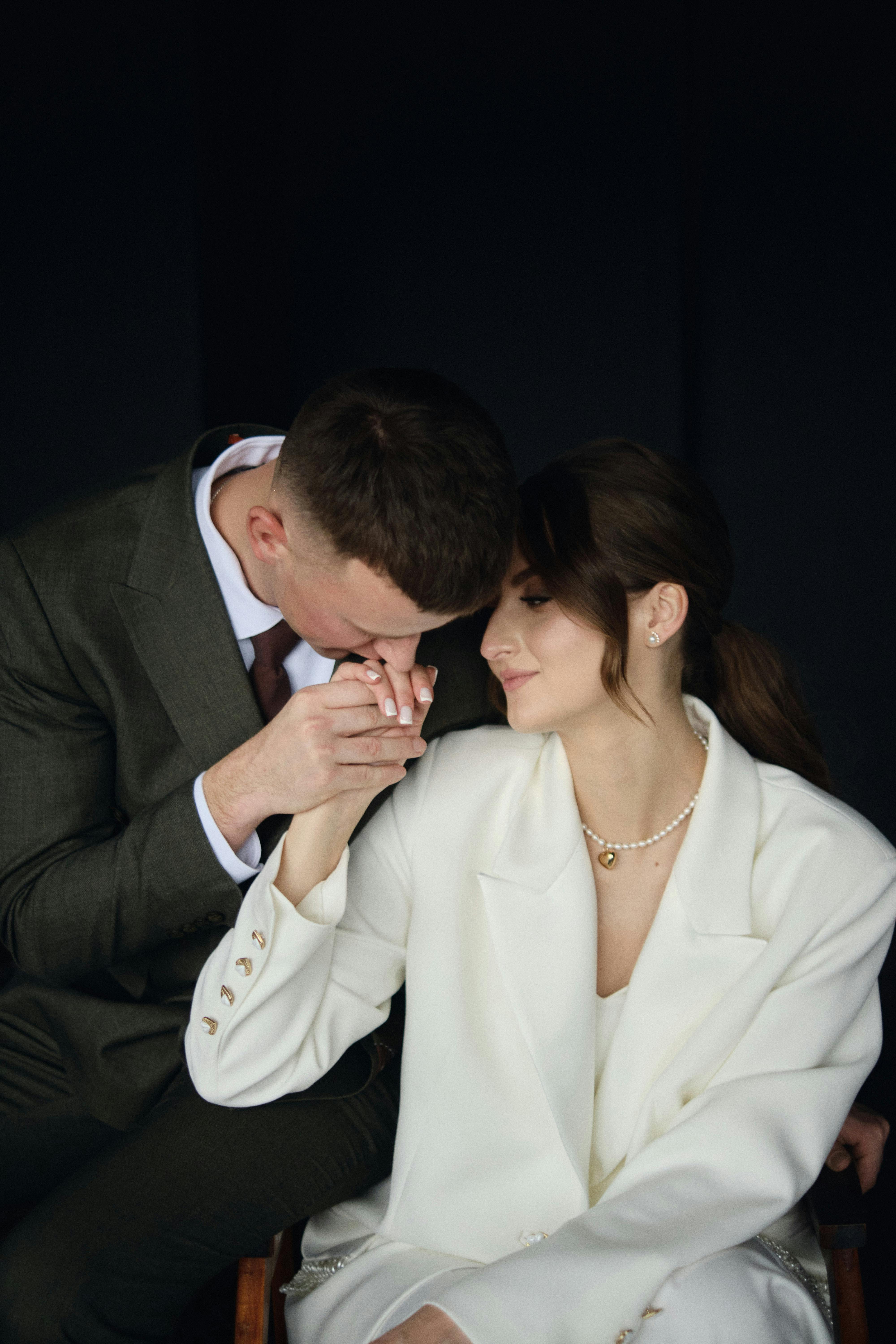Man in a Suit Kissing an Elegant Womans Hand · Free Stock Photo