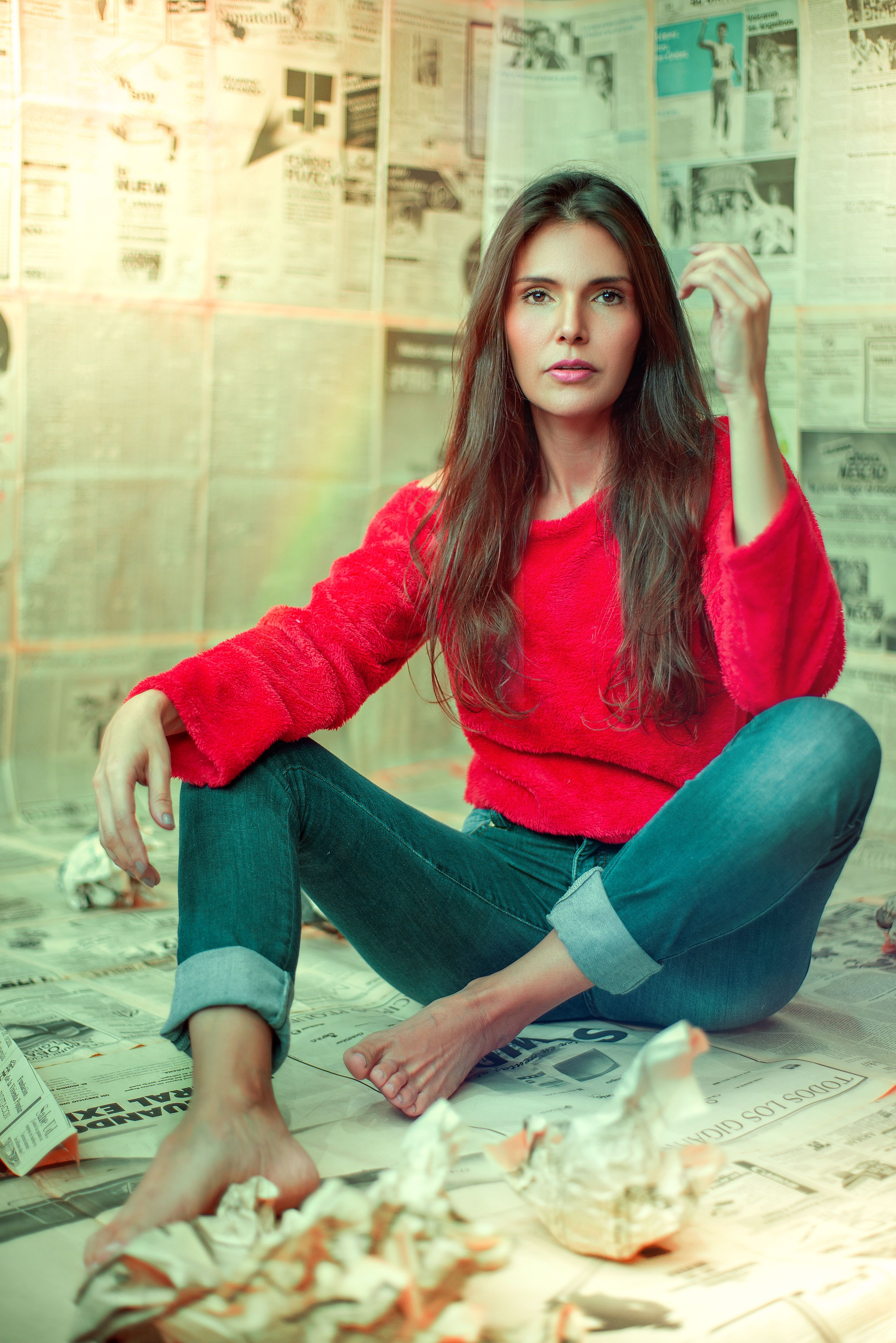 Woman Sitting around Newspapers · Free Stock Photo
