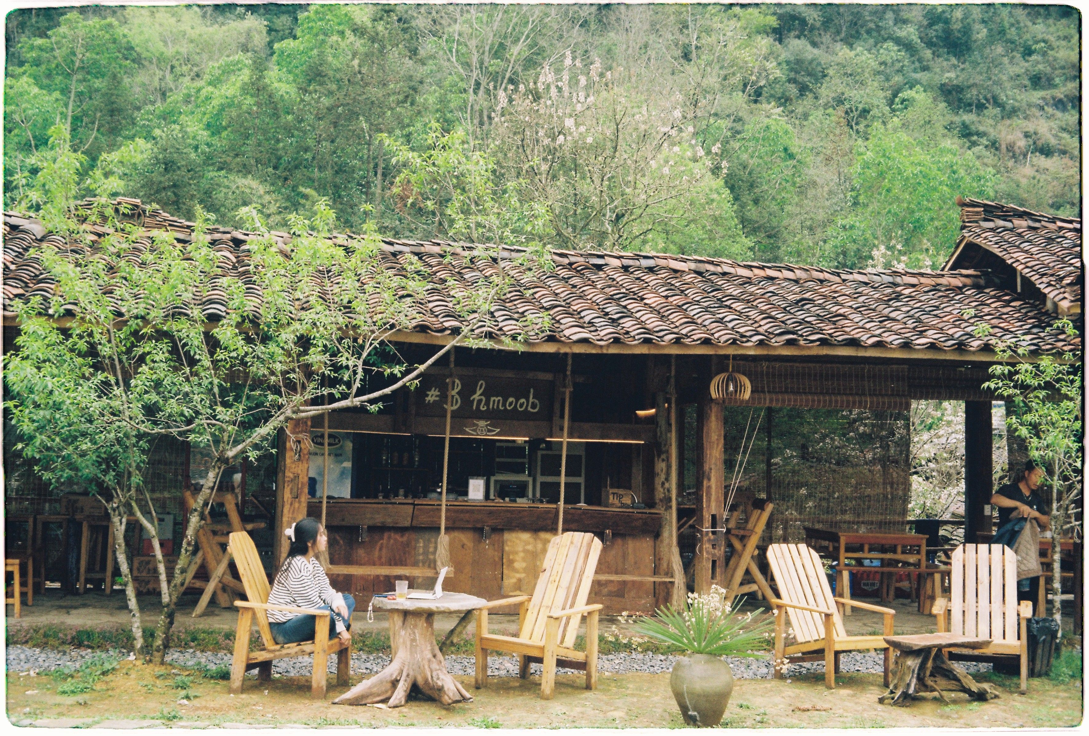 A wooden building with chairs and tables outside · Free Stock Photo