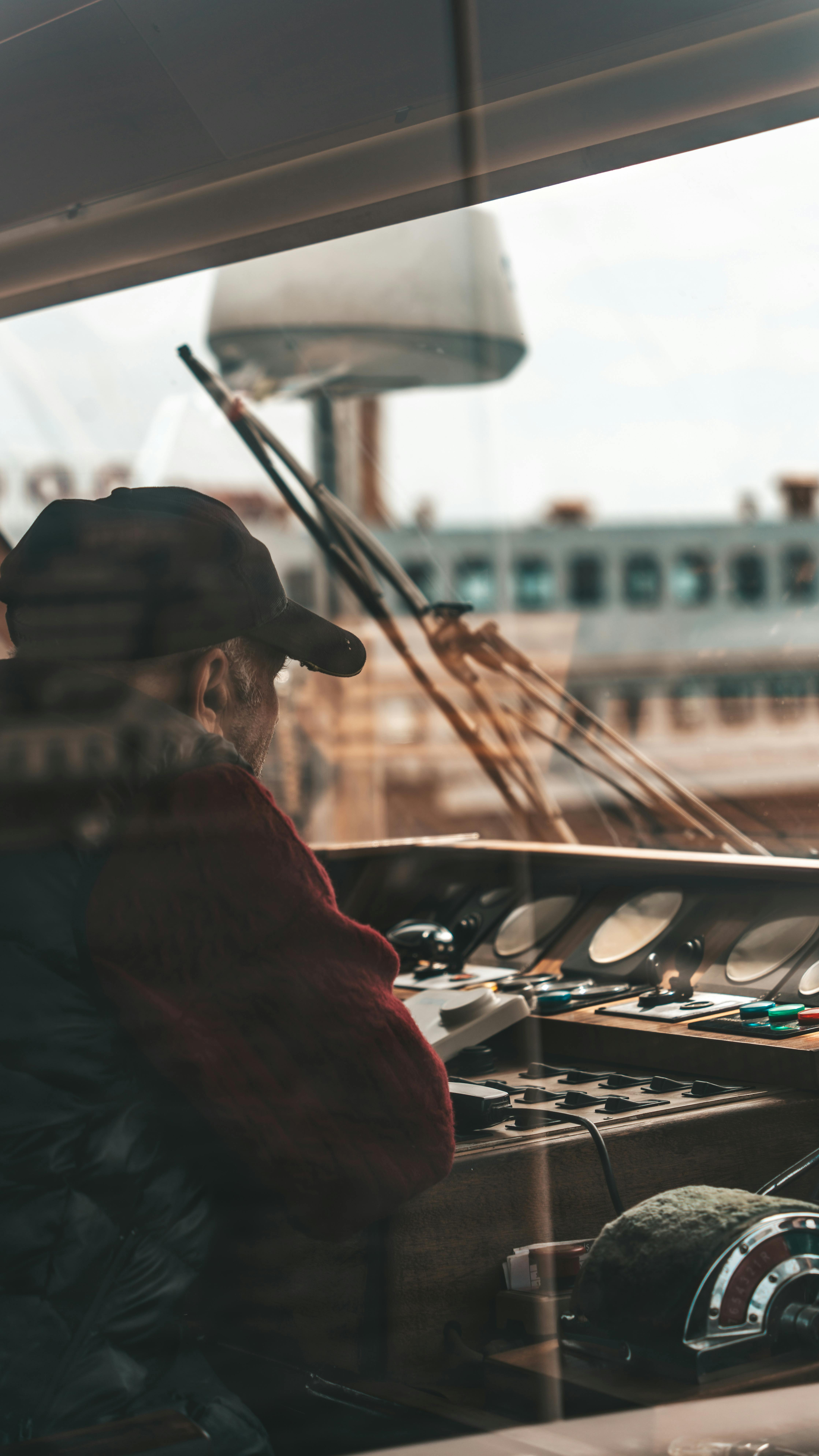 Man Navigating a Boat on Sea · Free Stock Photo