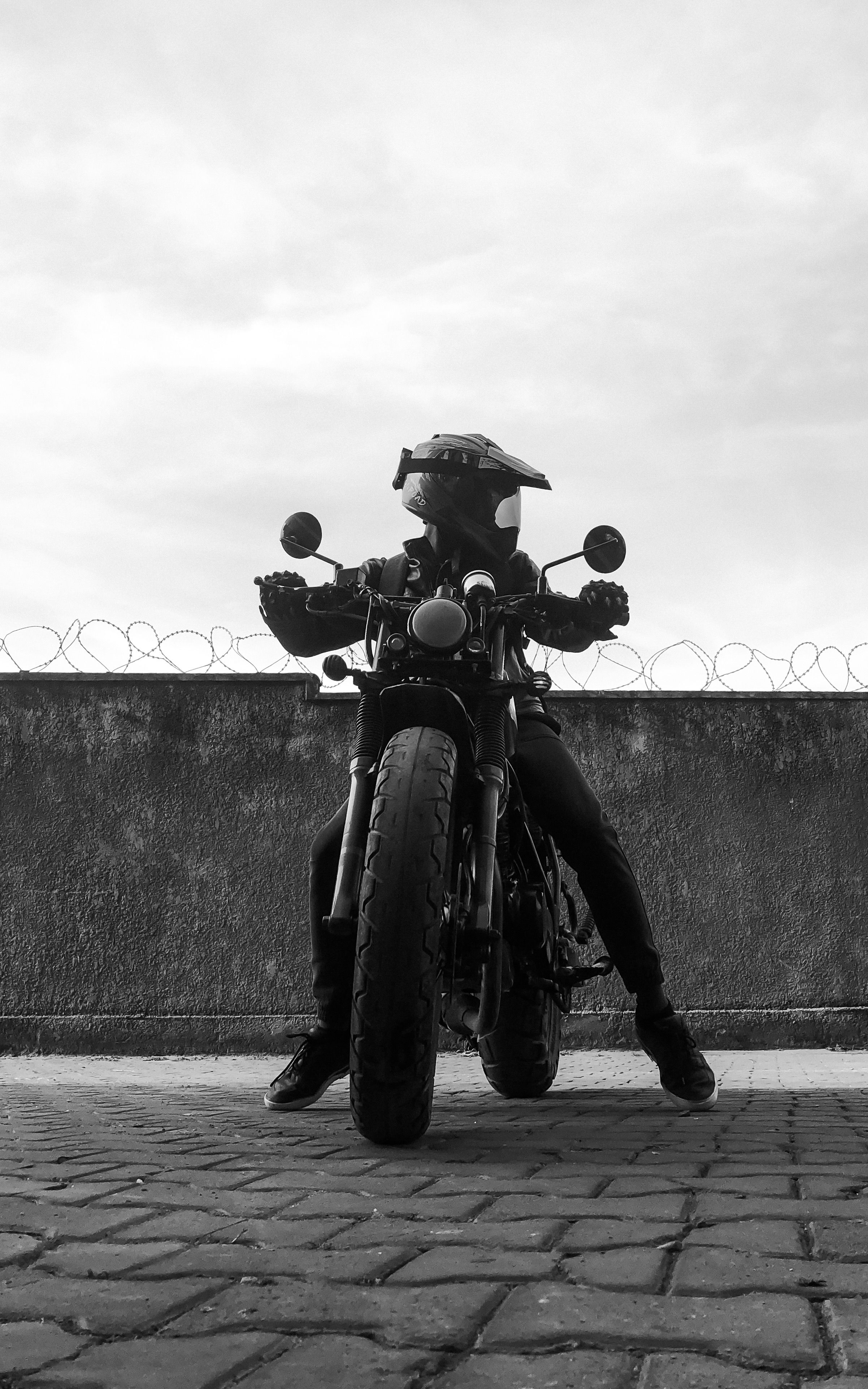 Biker Sitting on a Motorcycle Near a Barbed Wire Fence Wall · Free ...