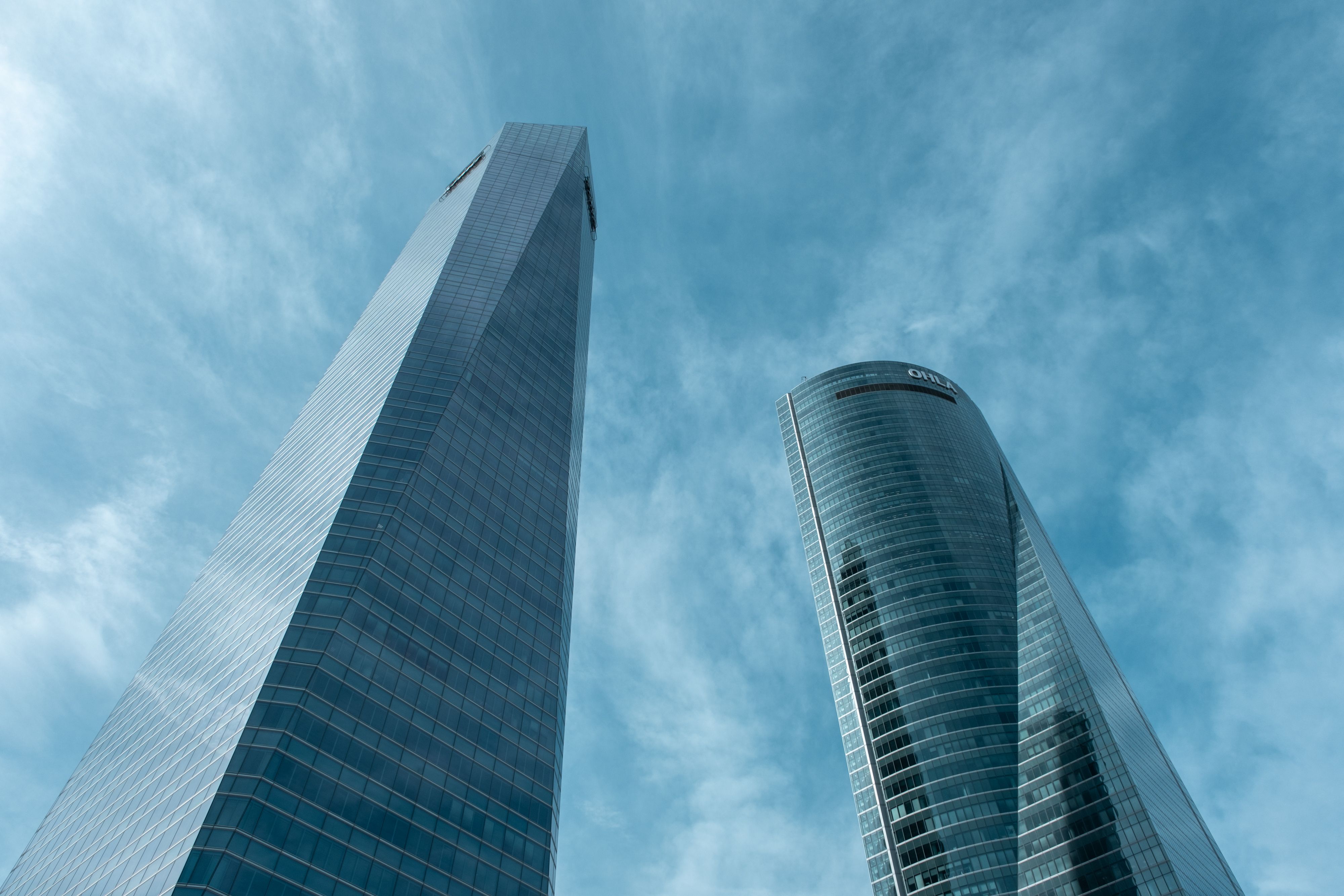 Two tall buildings with blue sky in the background · Free Stock Photo