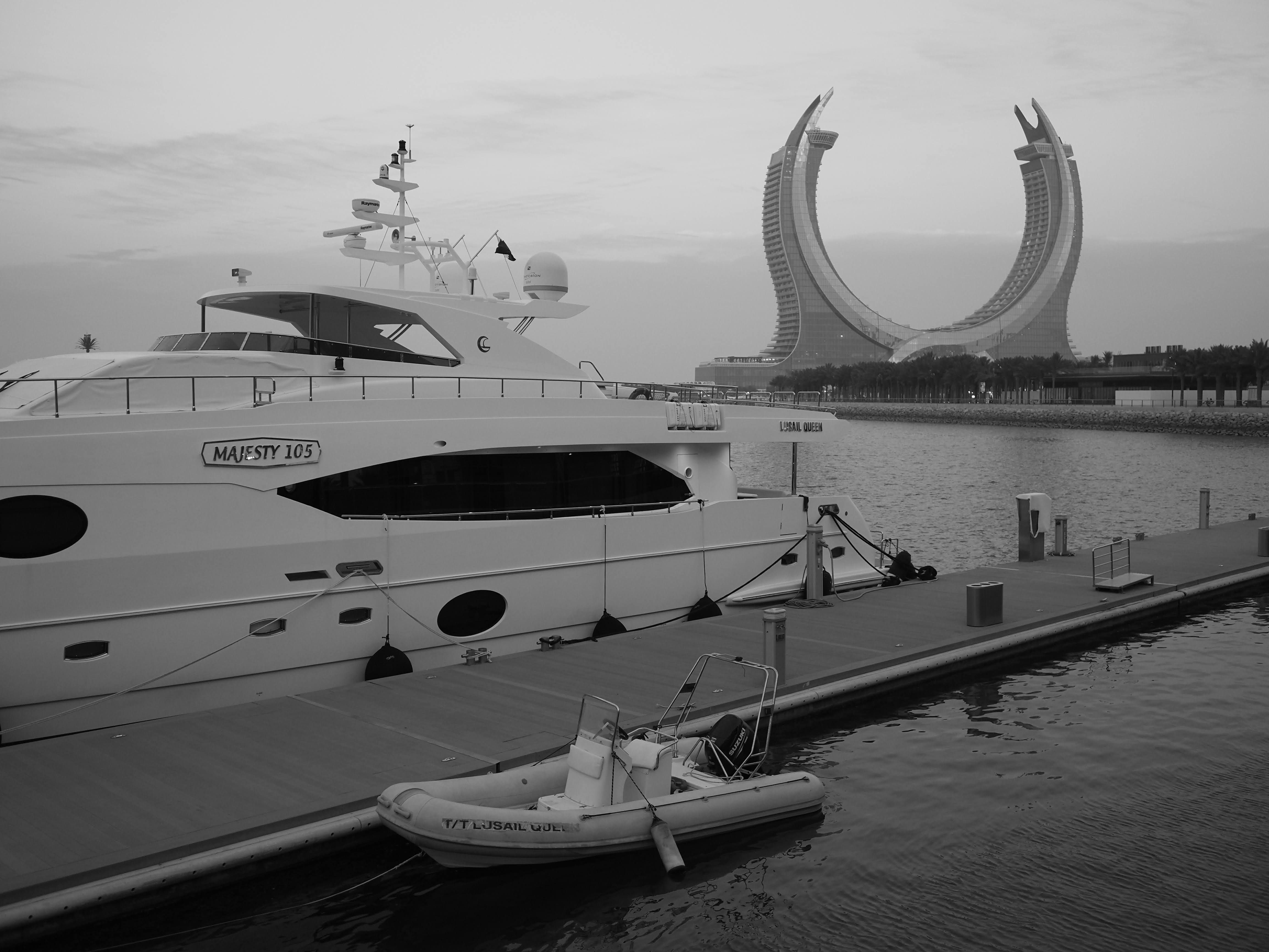 Crescent Tower Hotel behind Motor Yacht Moored on Sea Coast in Lusail ...