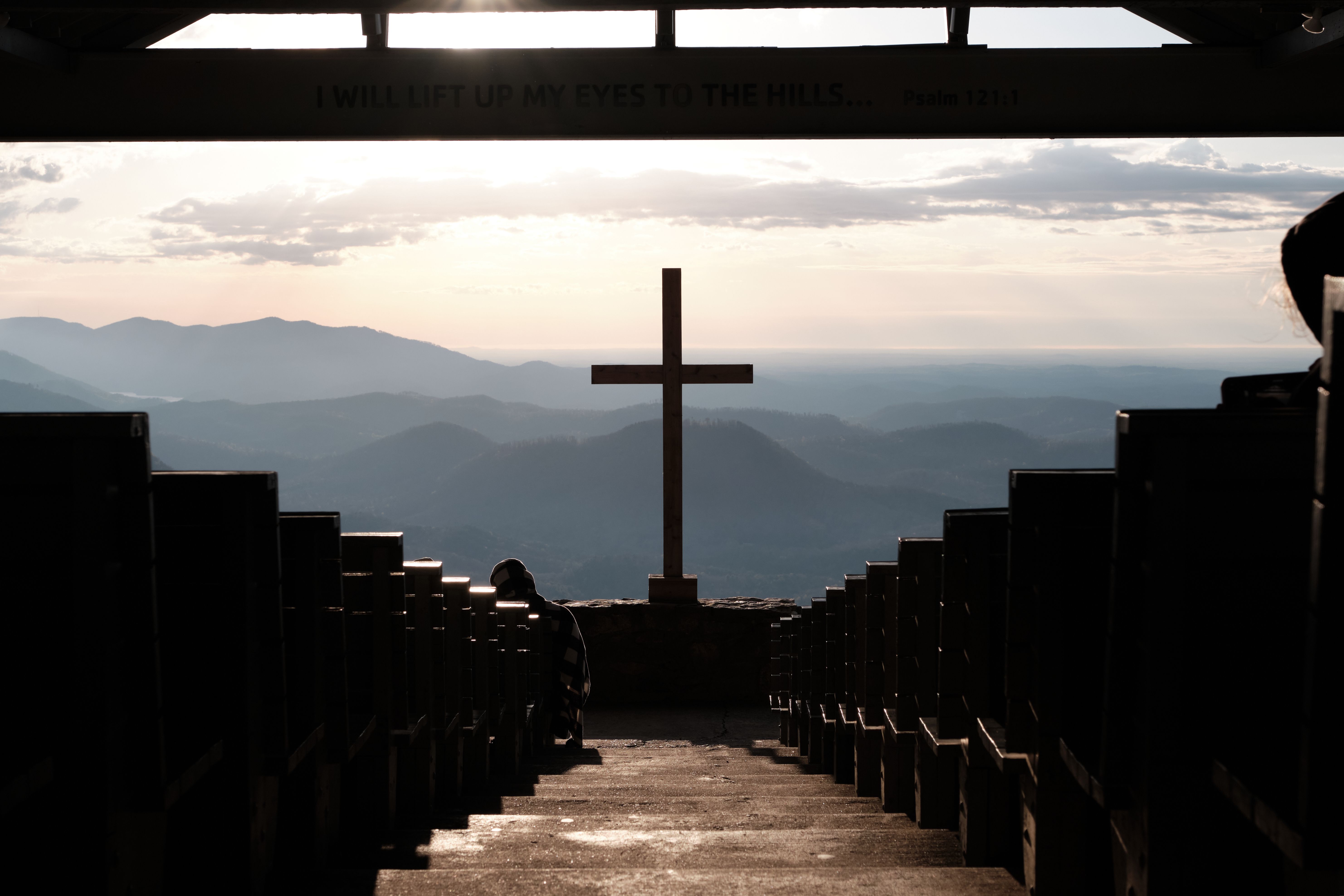 Cross in Church with Mountains Landscape behind · Free Stock Photo