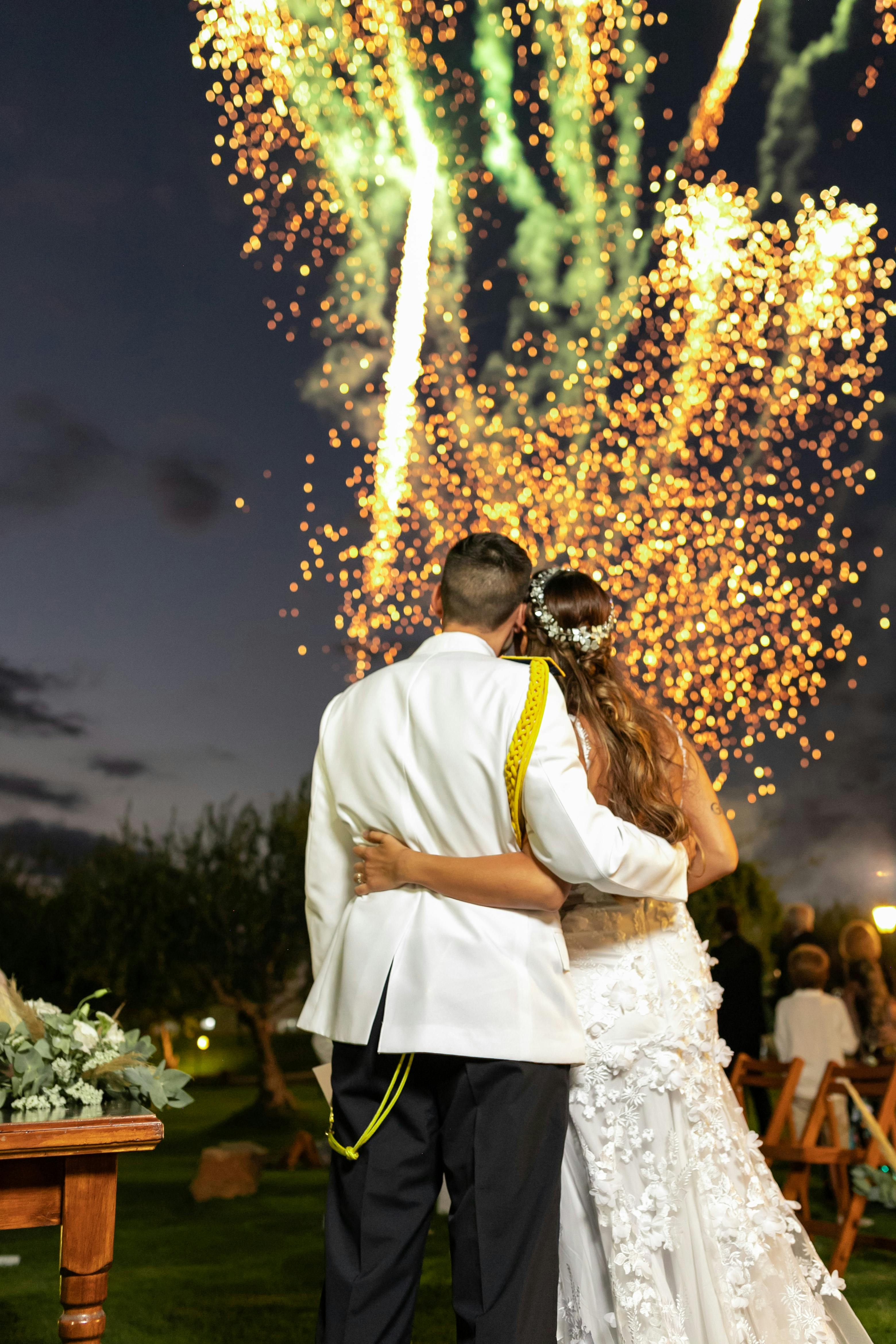 Embracing Couple Watching Fireworks Display · Free Stock Photo
