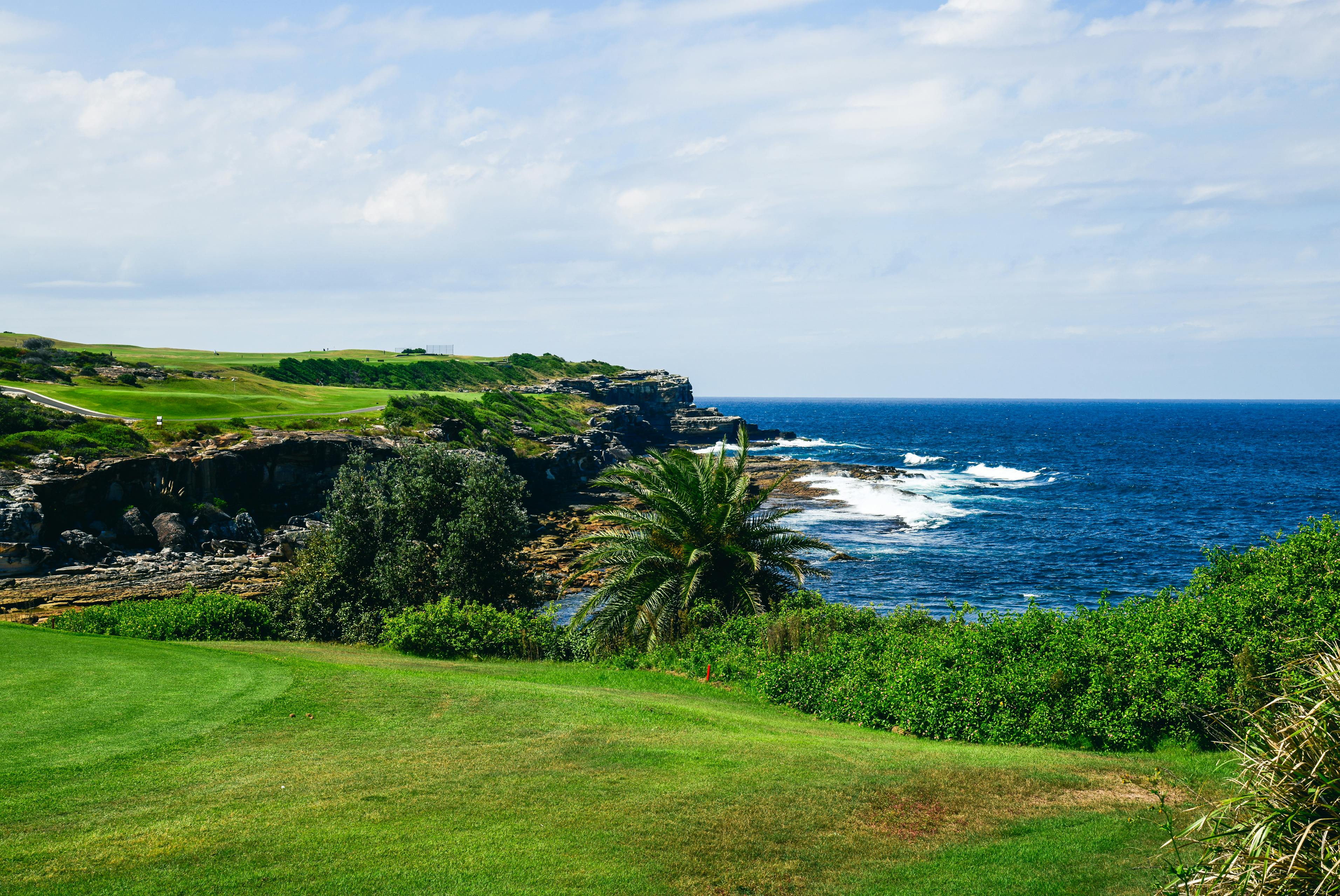 A golf course overlooking the ocean and the ocean · Free Stock Photo