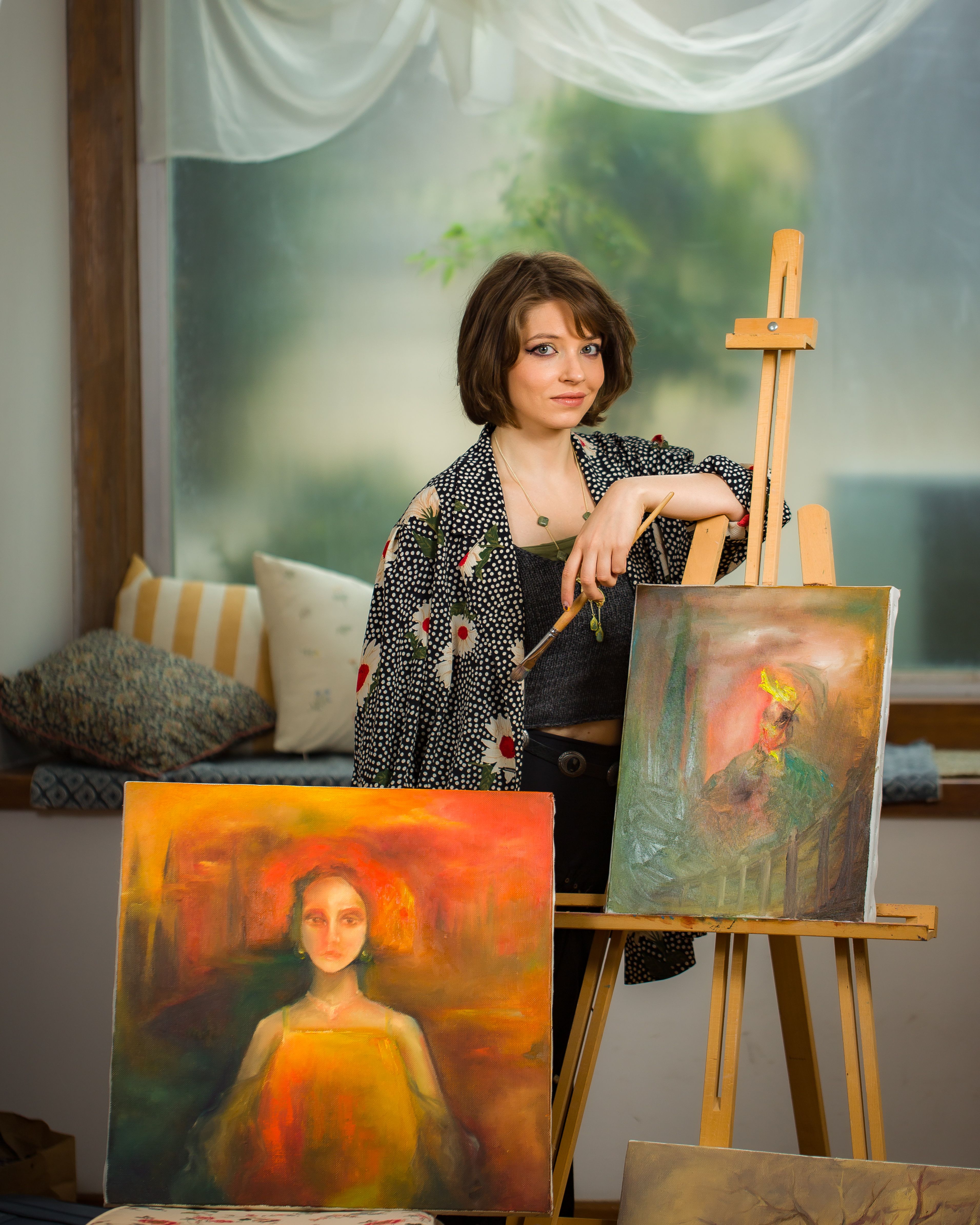 Brunette Painter Standing by Paintings at Exhibition · Free Stock Photo