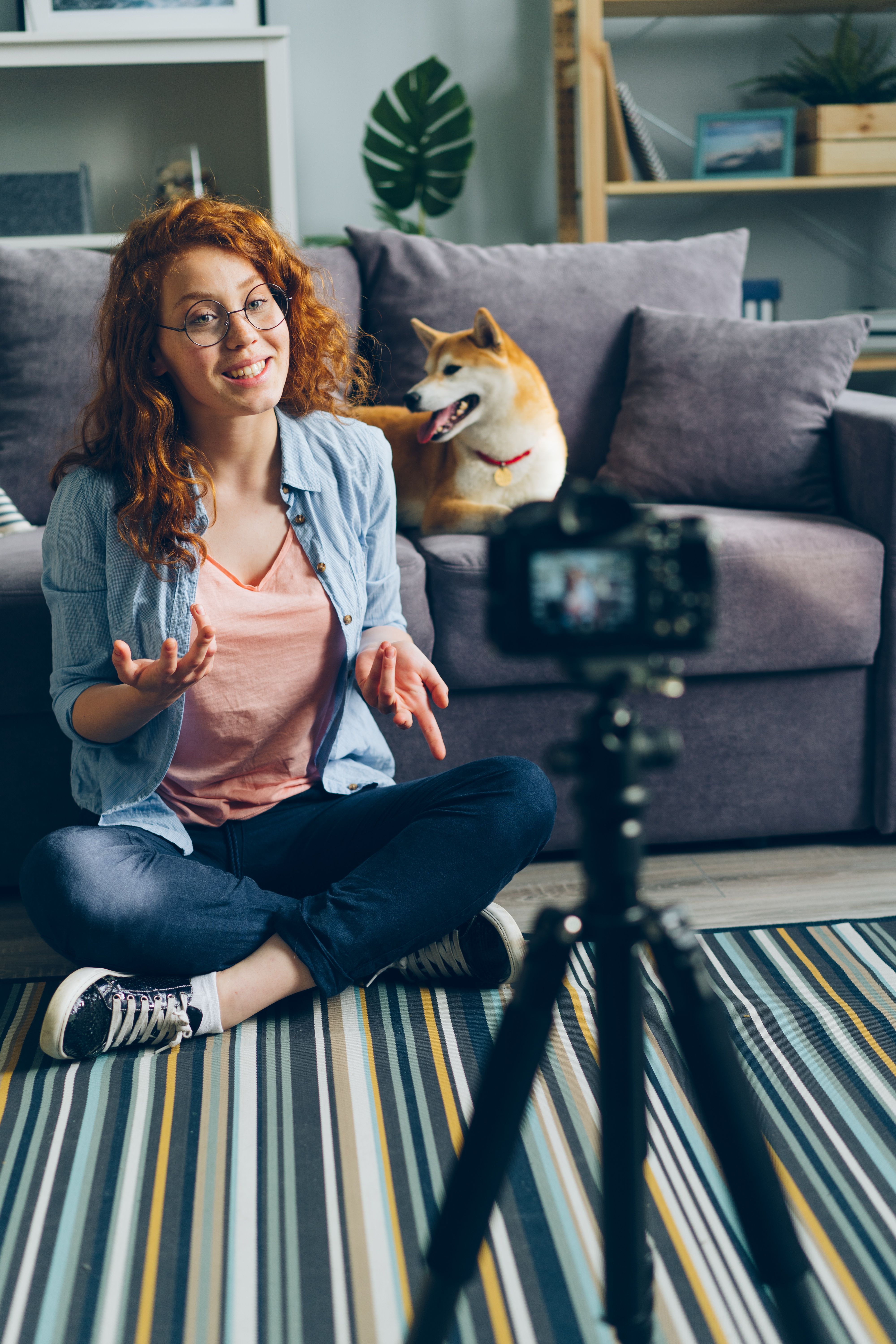 Camera and Smiling Woman Sitting behind · Free Stock Photo