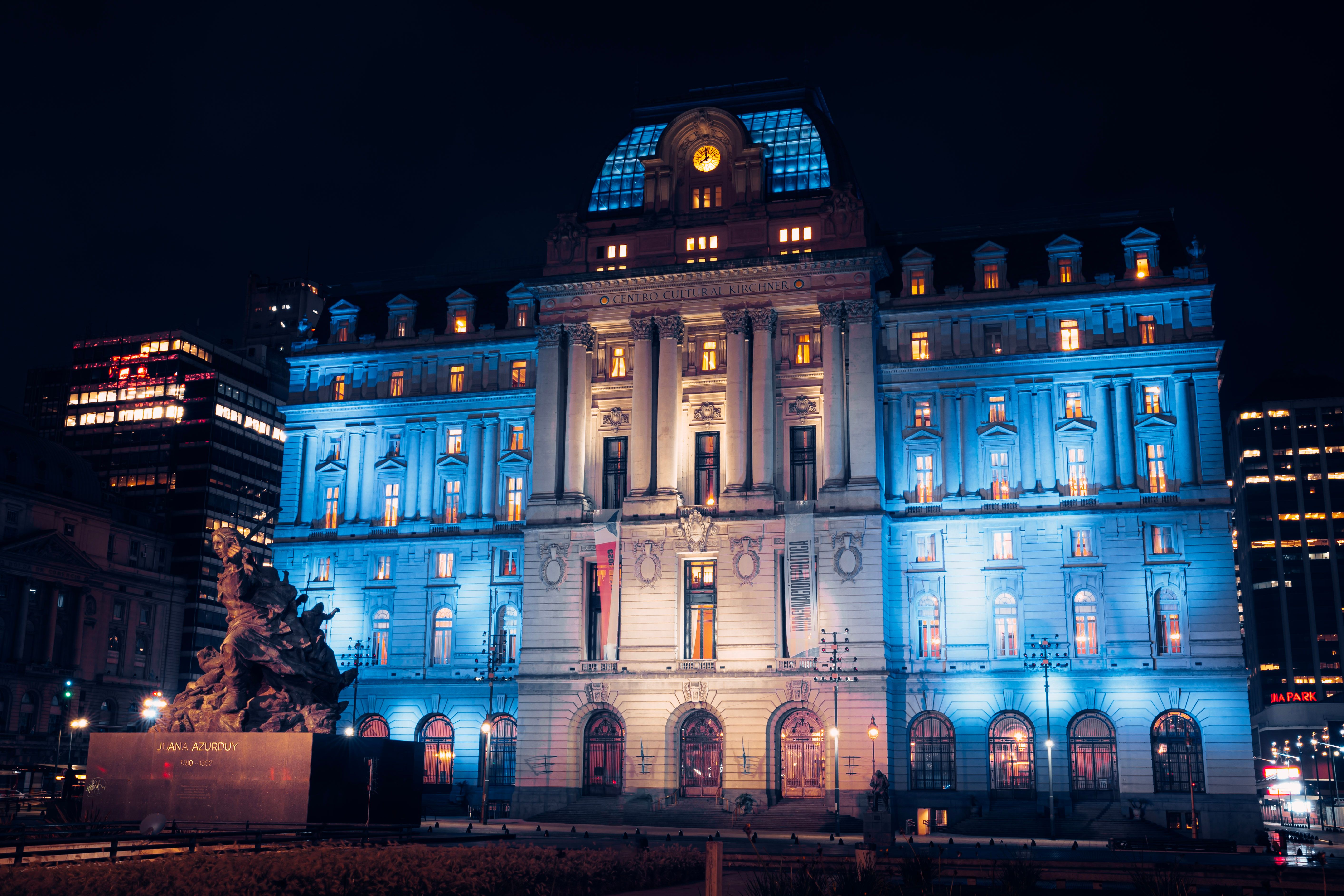 A large building lit up blue at night · Free Stock Photo