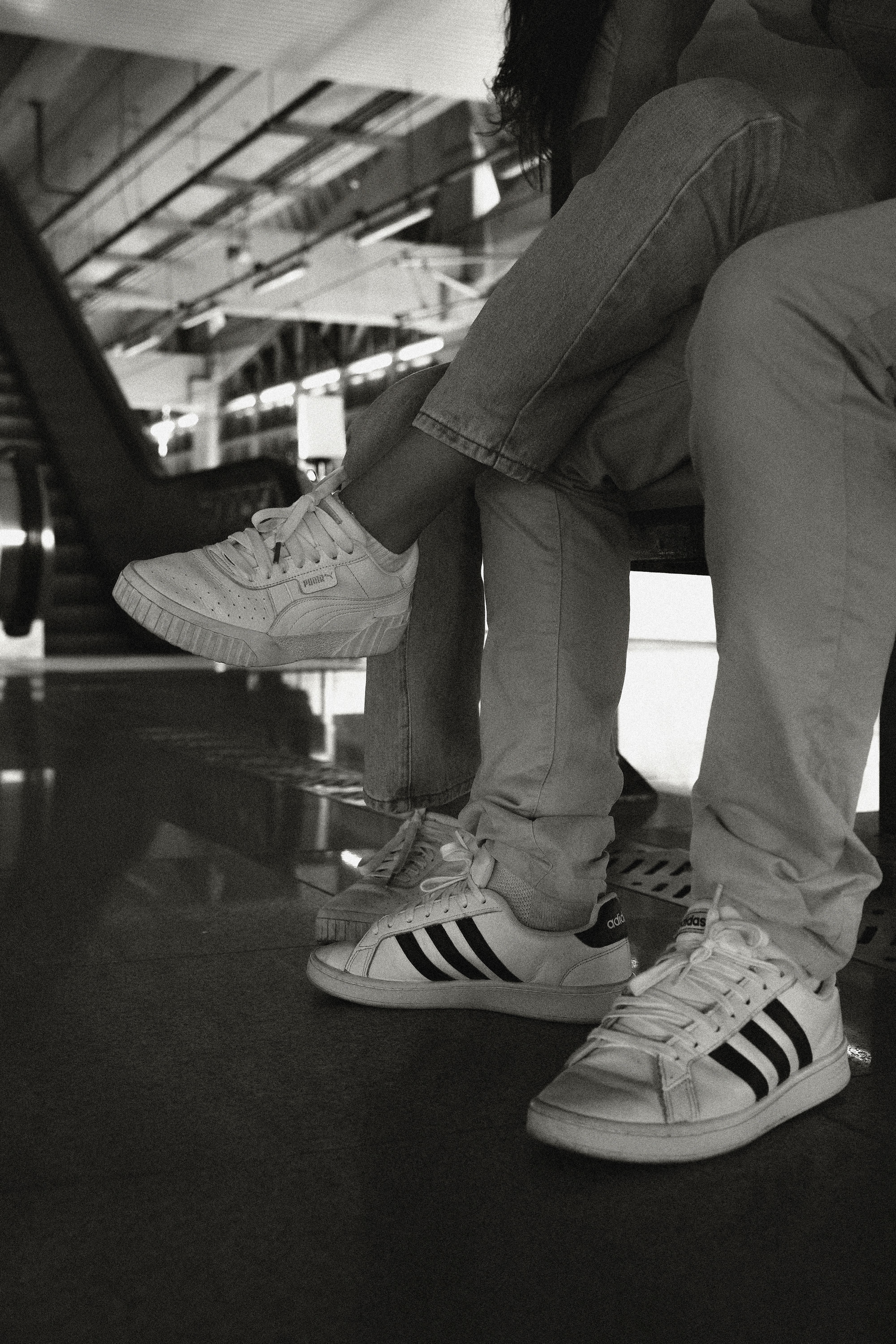 Legs and Shoes of Couple Sitting Together · Free Stock Photo