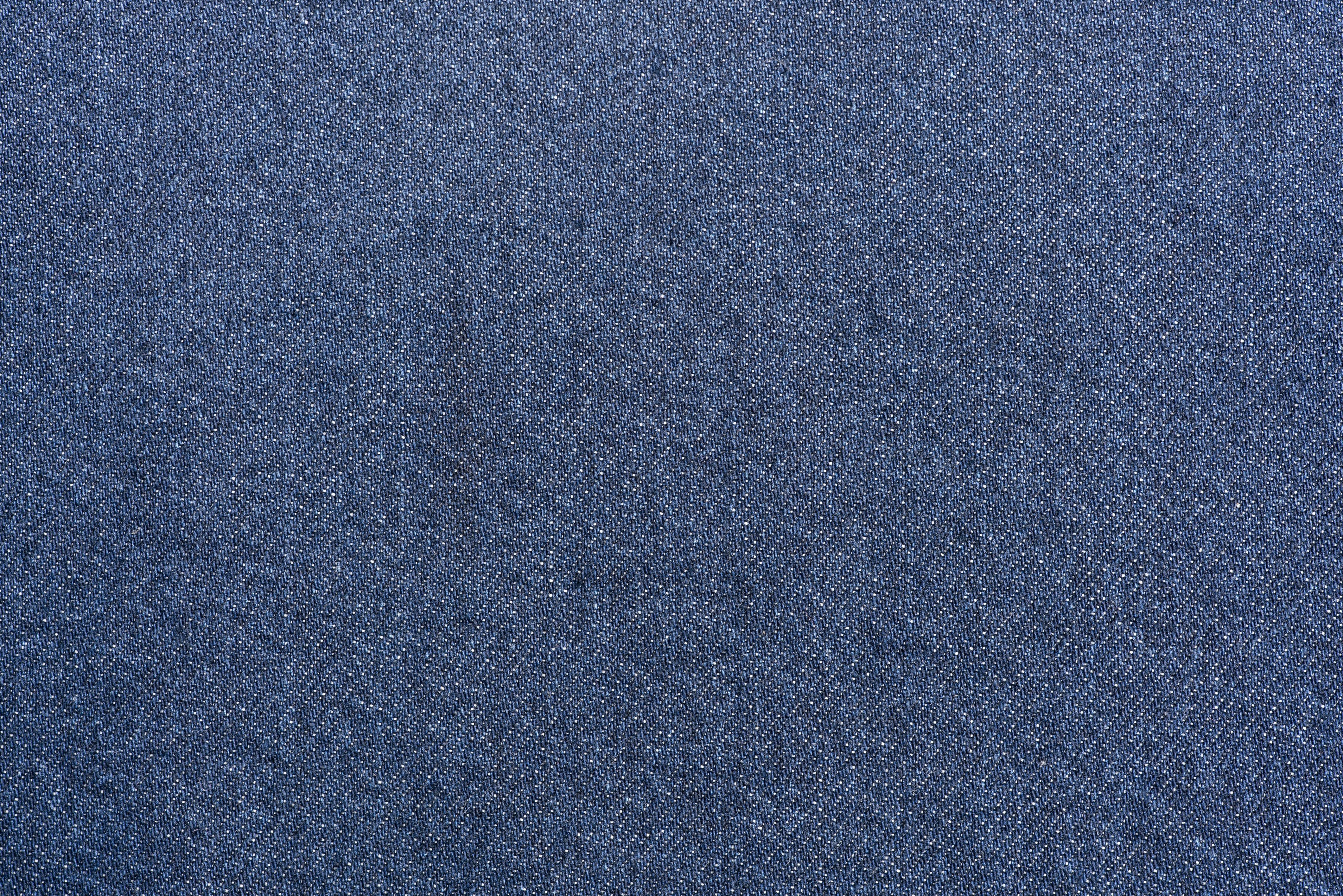 A blue fabric with a small hole in it · Free Stock Photo