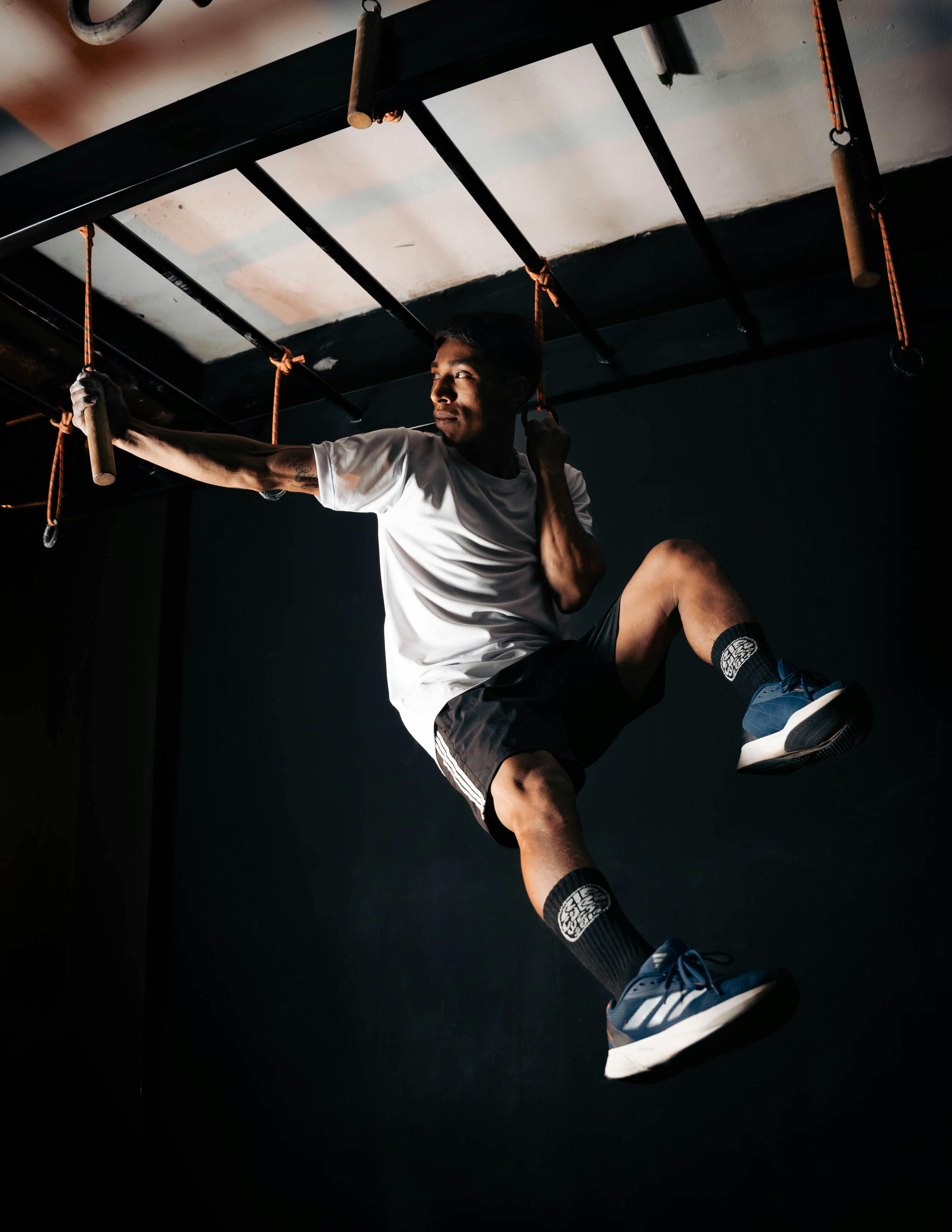 A man doing pull ups on a rope · Free Stock Photo