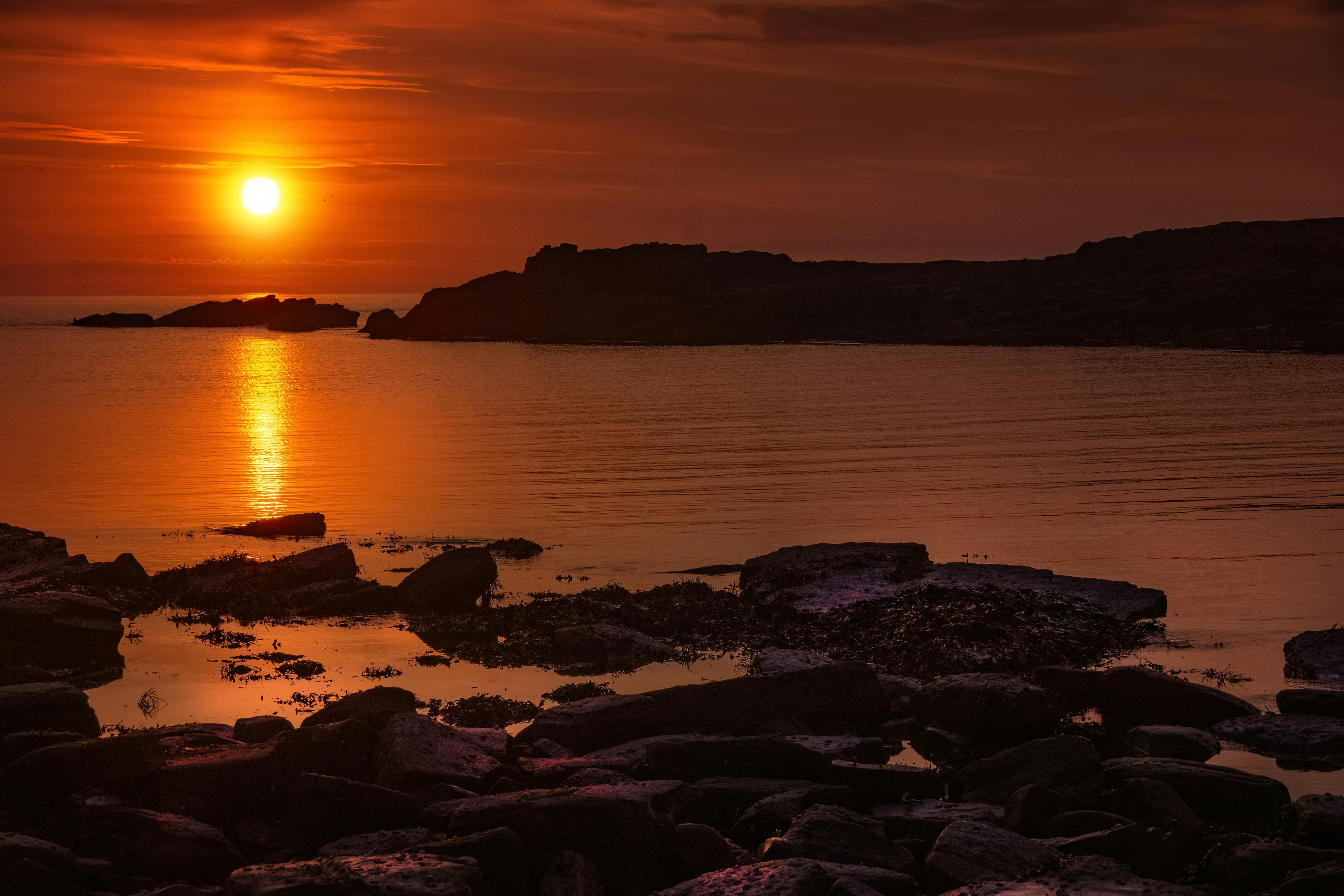 Sunrise Over Rocks on the Sea · Free Stock Photo