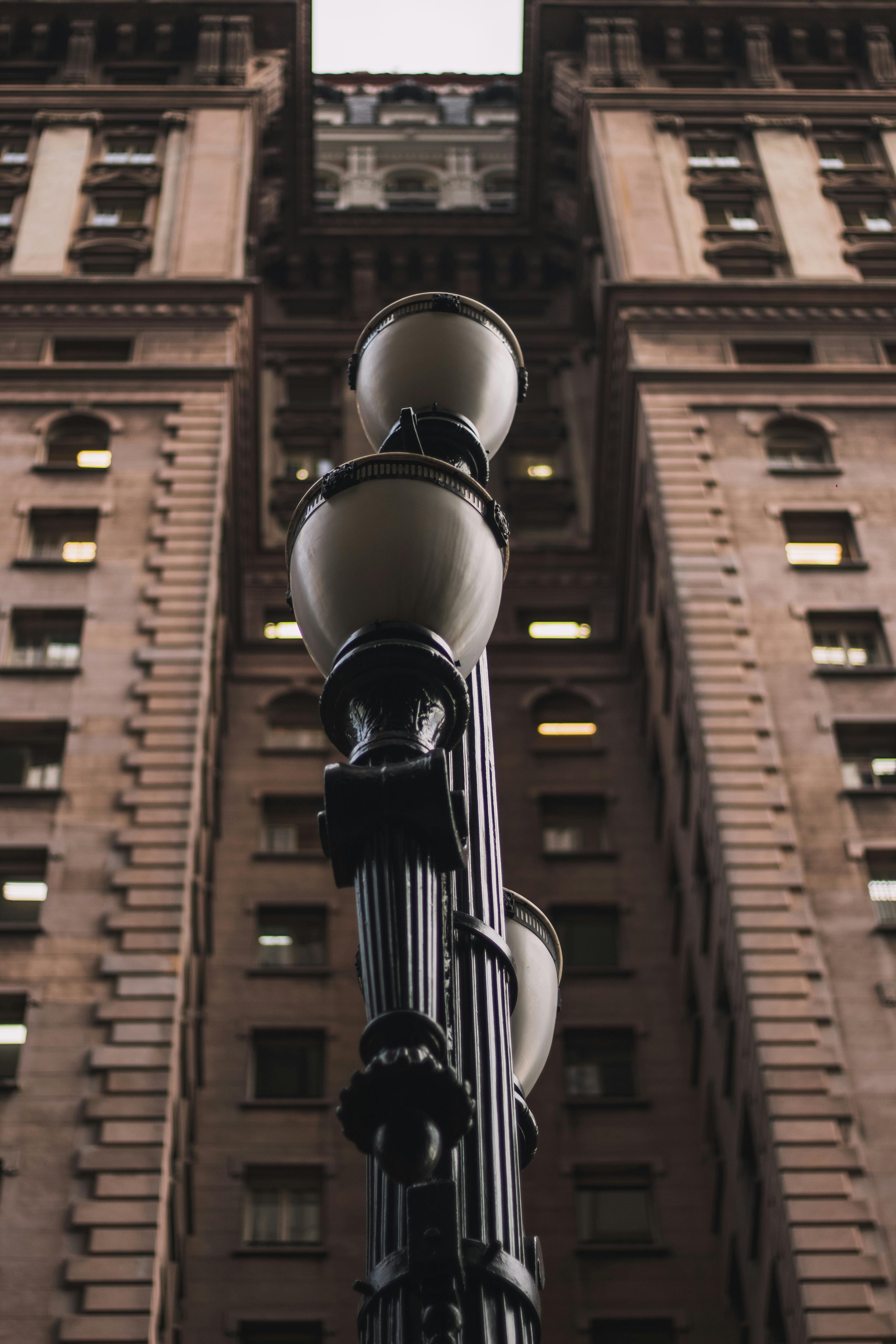 Black Light Post in Front of Brown Building · Free Stock Photo