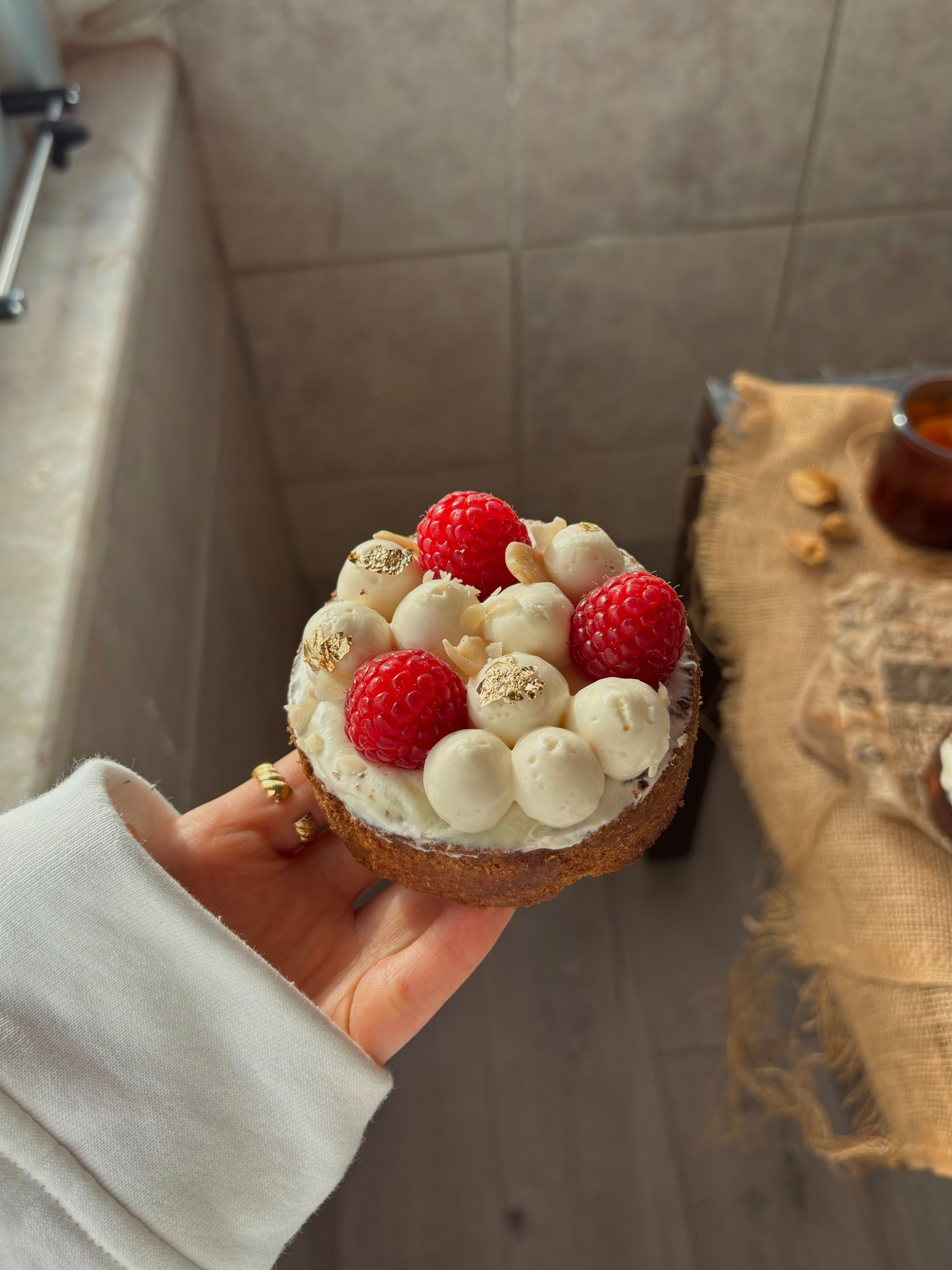 Hand of a Person Holding a Small Ready-to-Eat Cake · Free Stock Photo