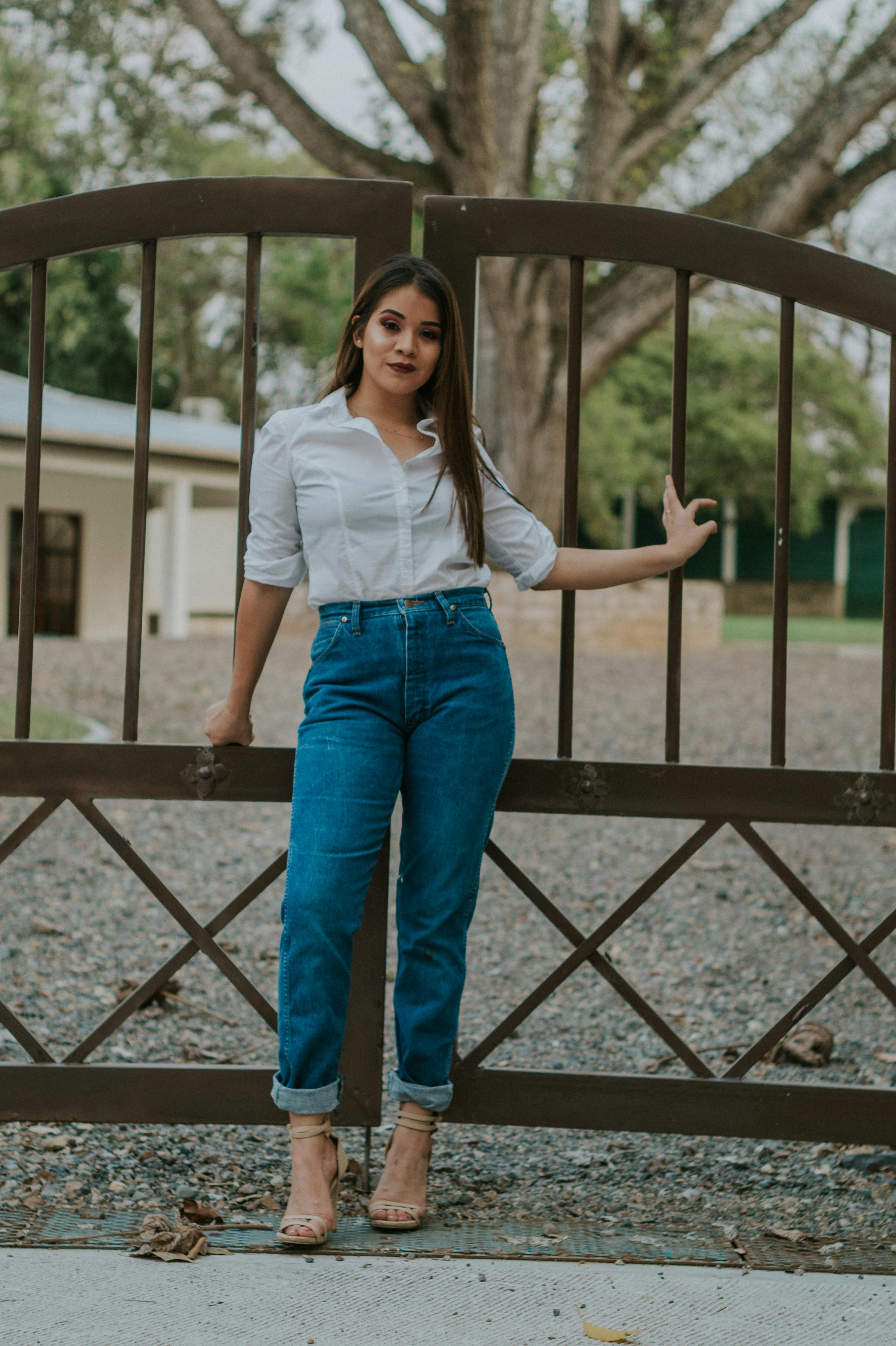 Woman Standing And Leaning On Gate · Free Stock Photo