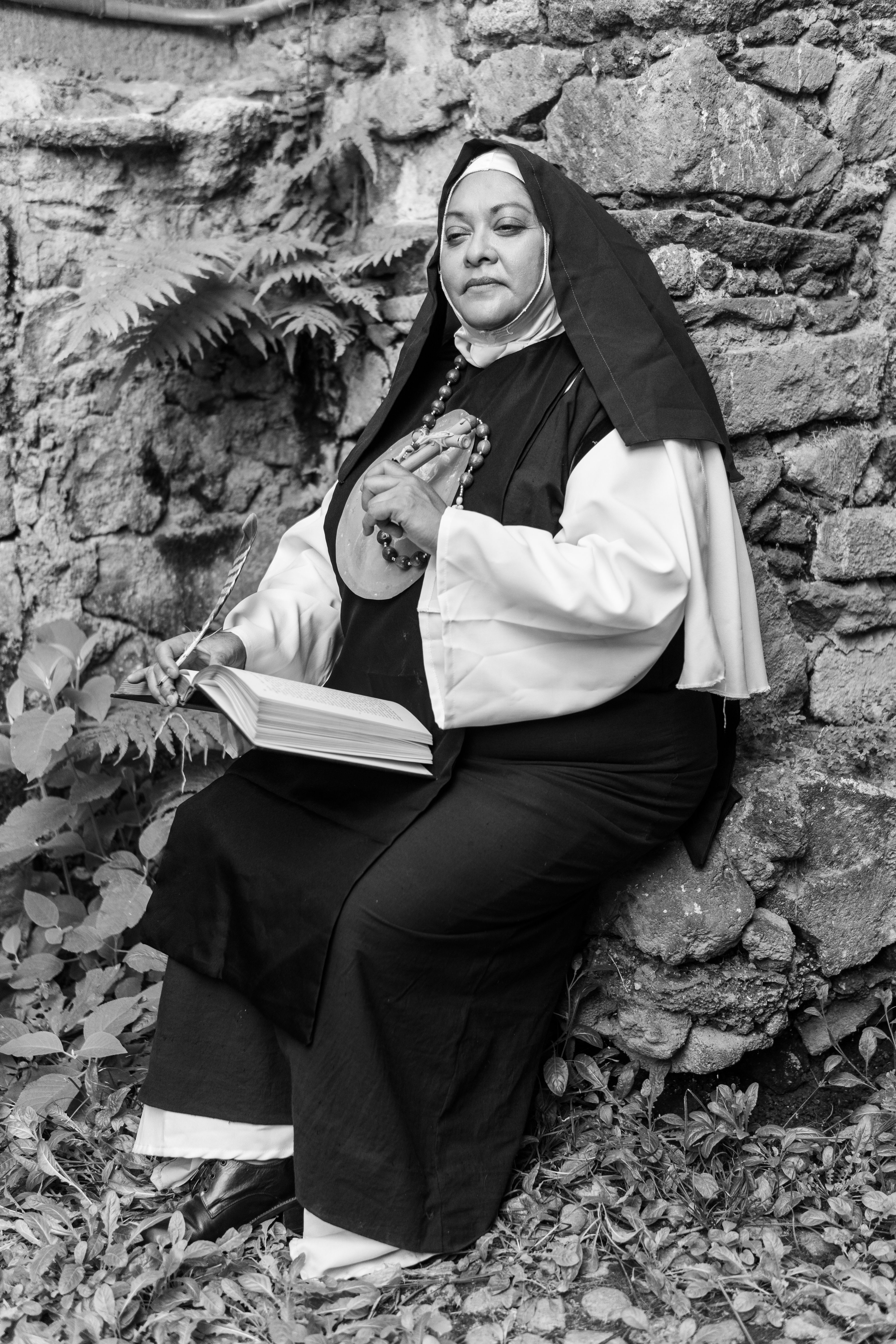 A Nun Sitting Outdoors · Free Stock Photo