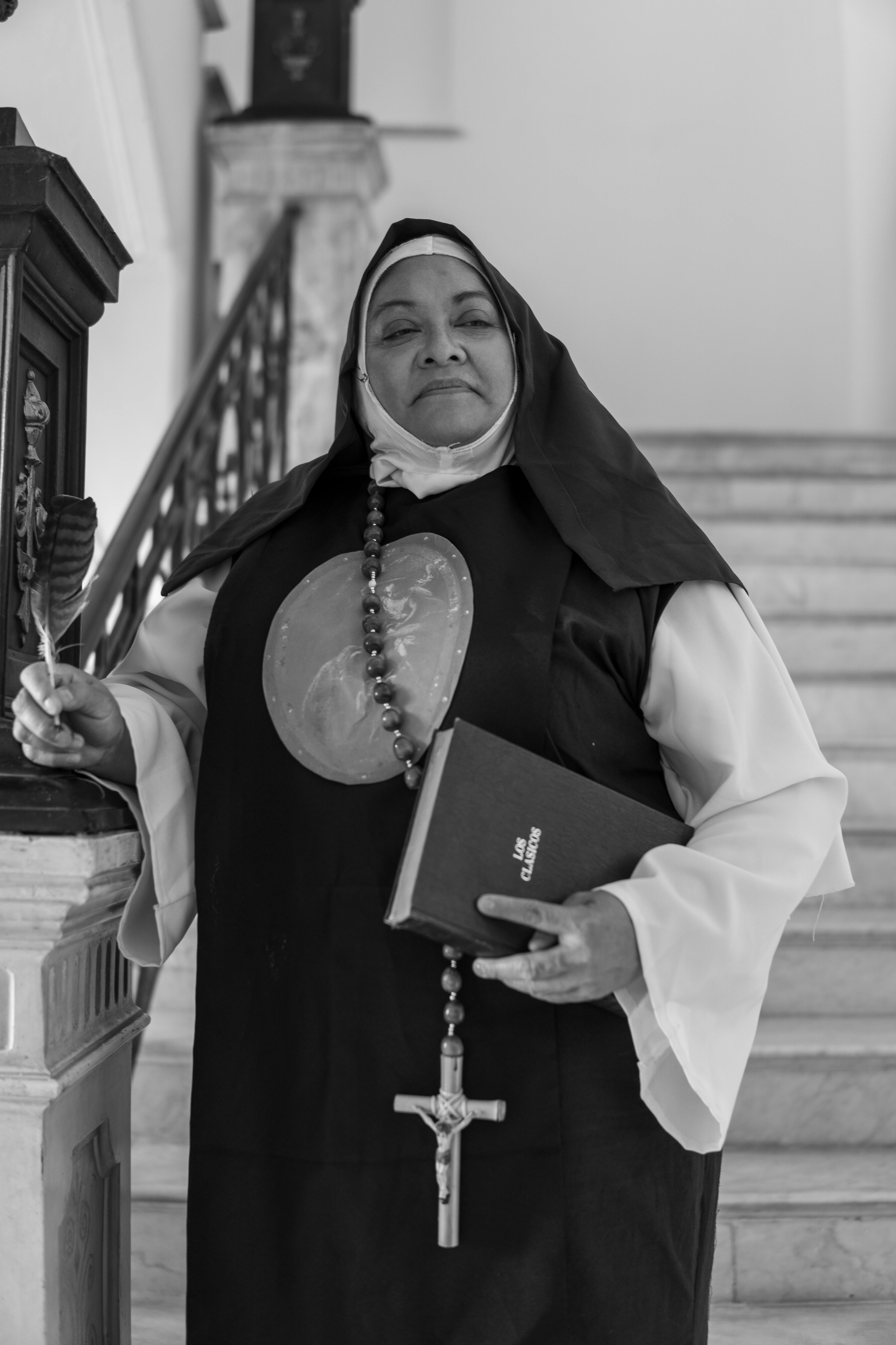 A Nun Standing with a Book · Free Stock Photo