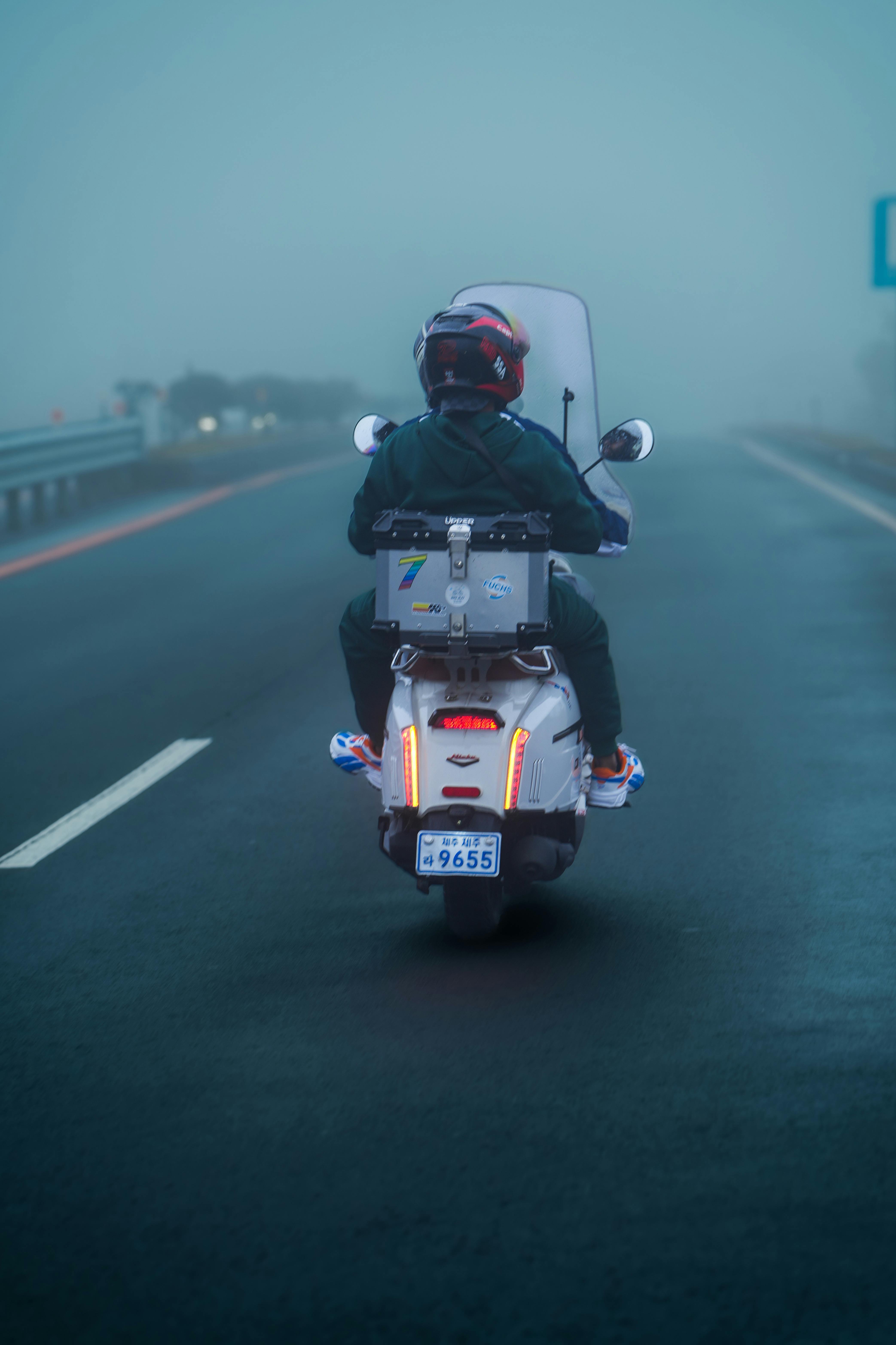Man Riding Motor Scooter on Road · Free Stock Photo