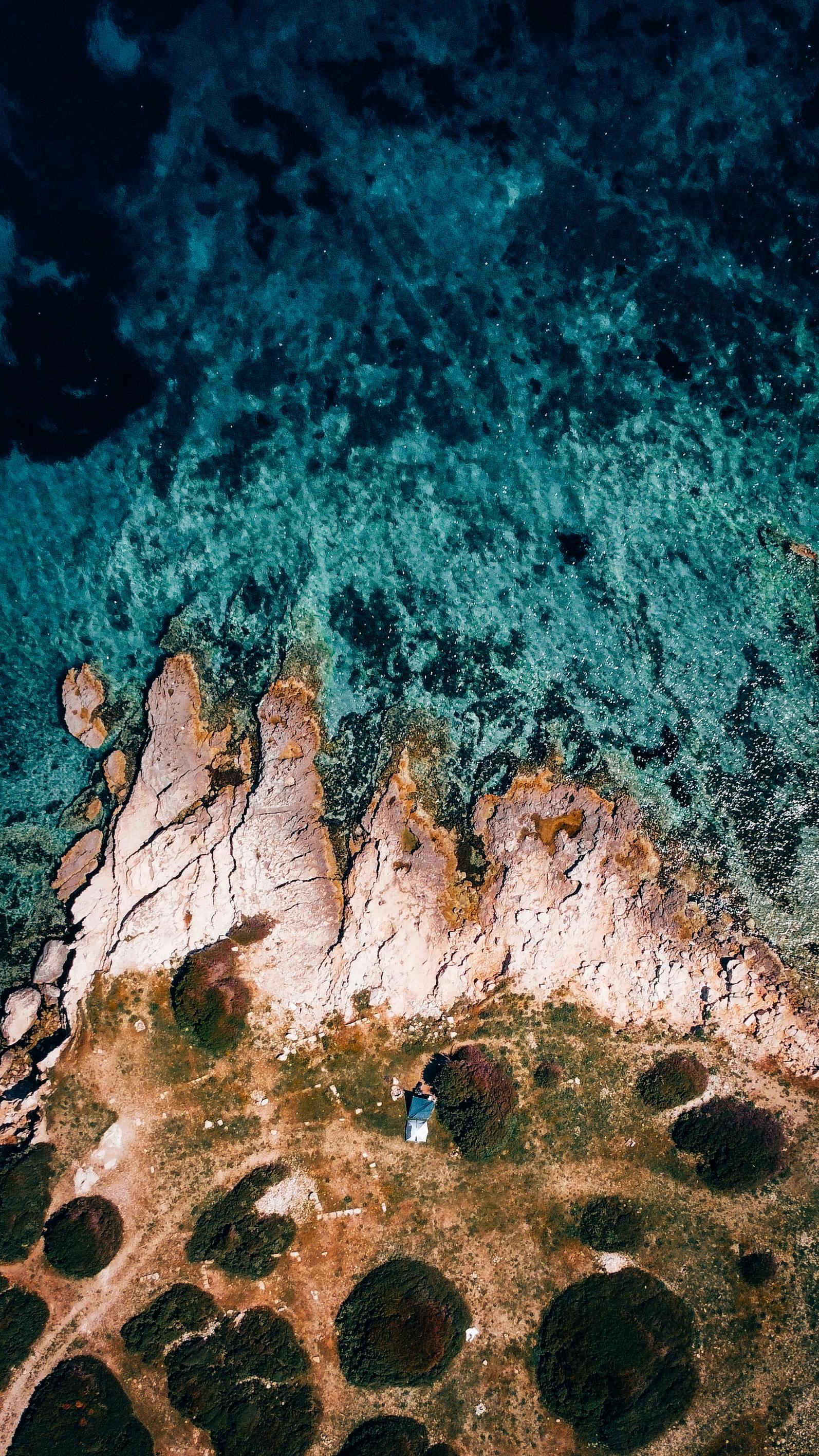 Aerial view of a beach with rocks and water · Free Stock Photo