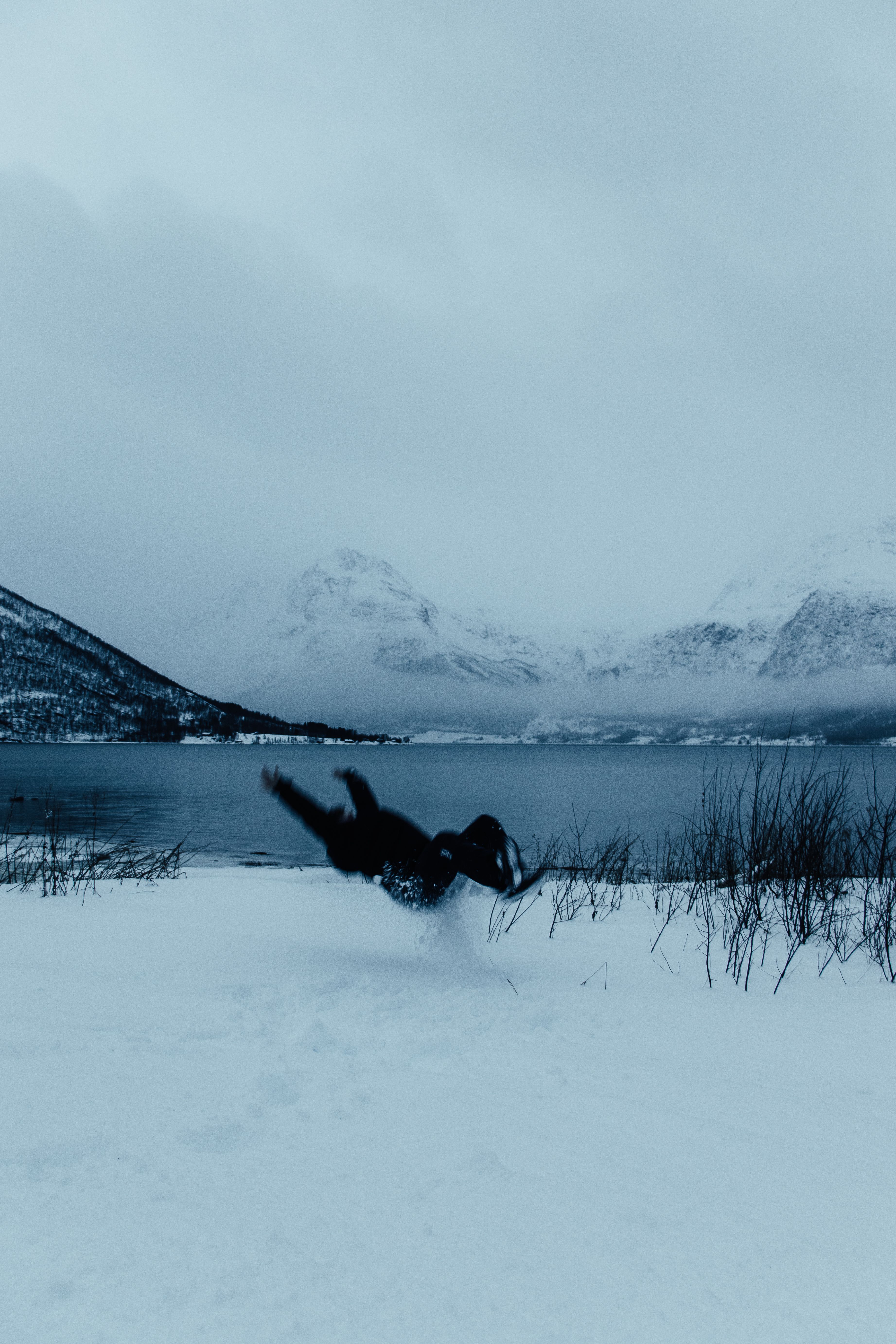 A person is flying through the air in the snow · Free Stock Photo