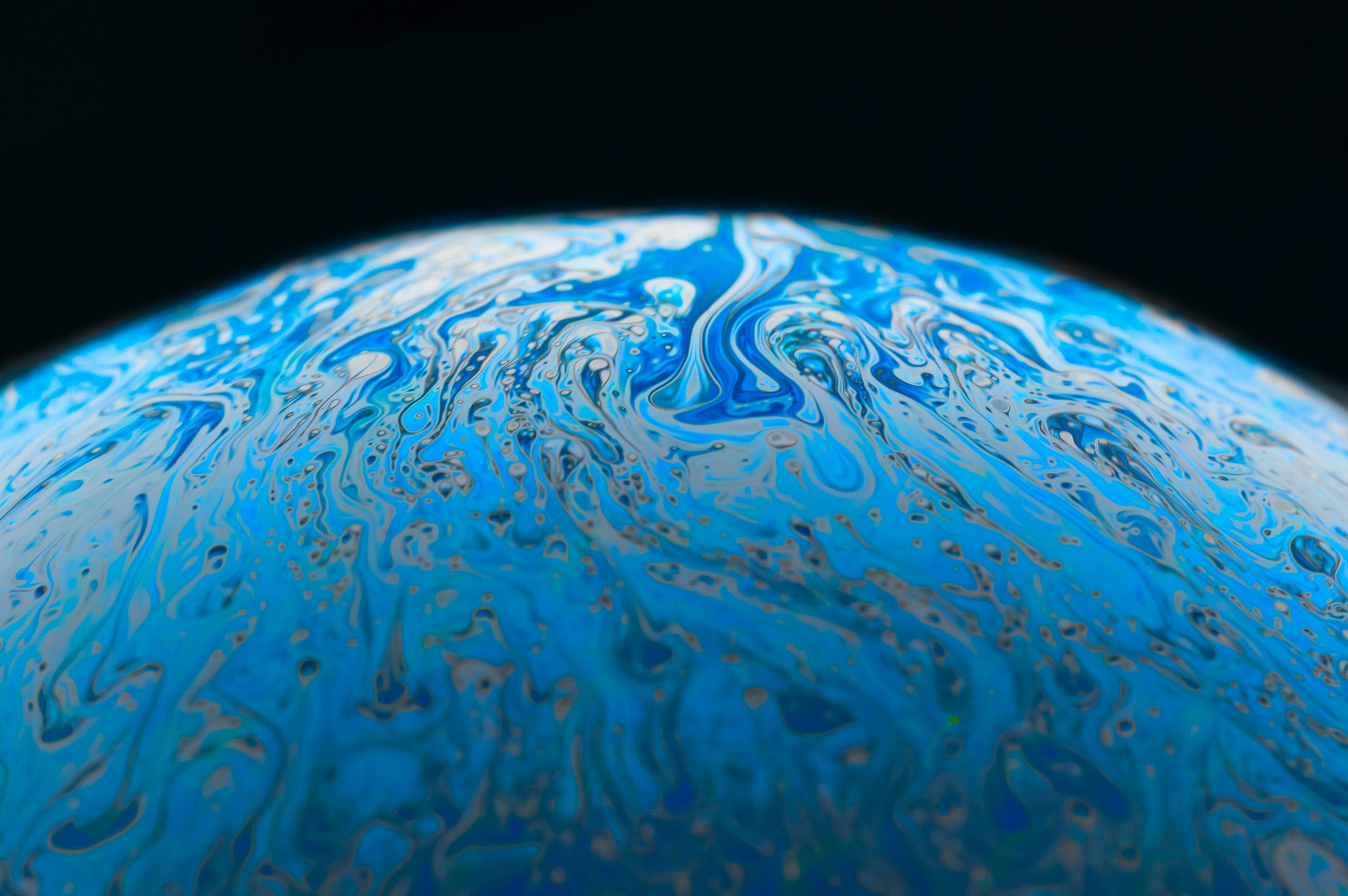 A close up of a blue planet with swirls · Free Stock Photo