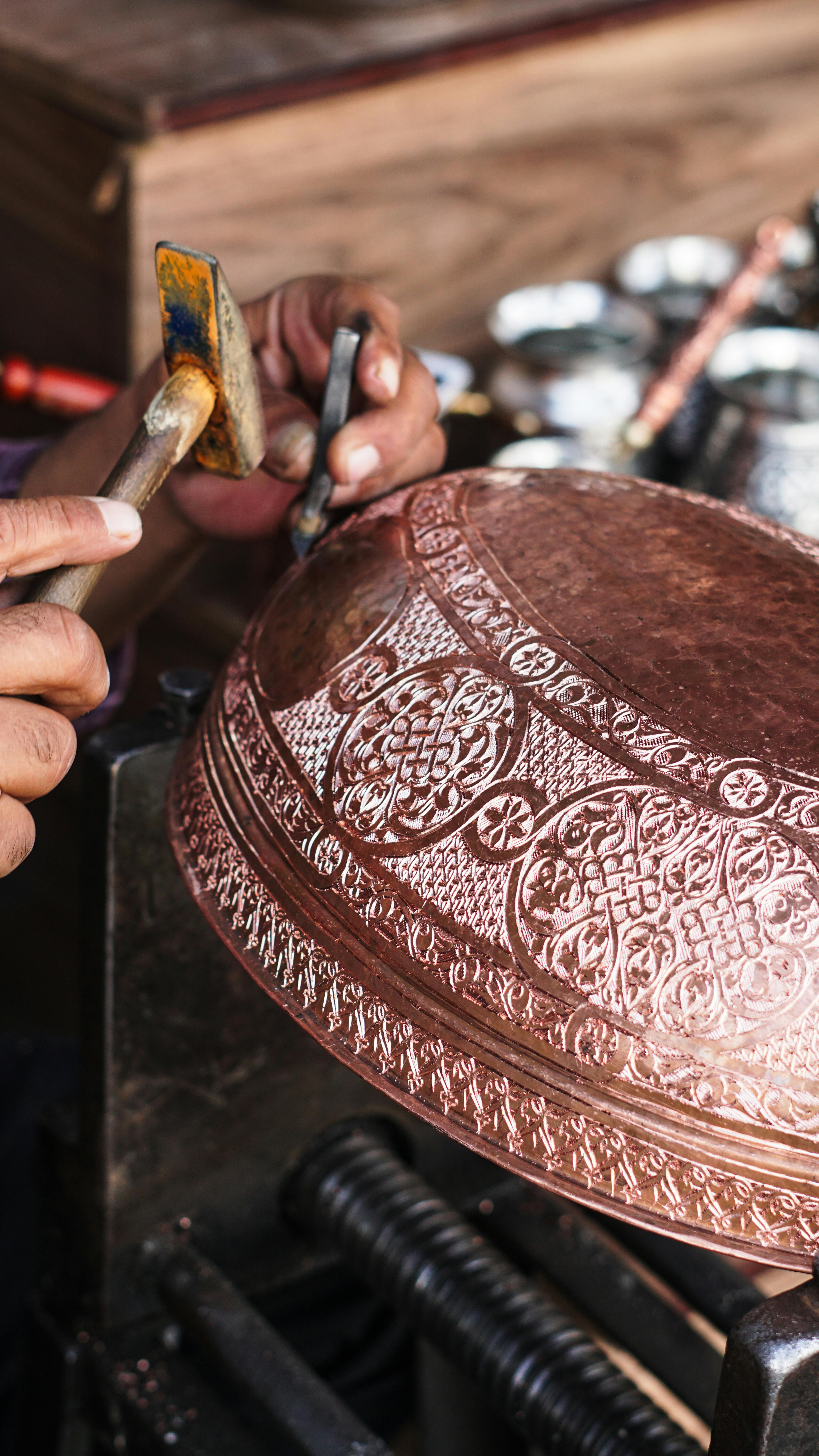 Person Chasing Pattern on Copper Bowl · Free Stock Photo