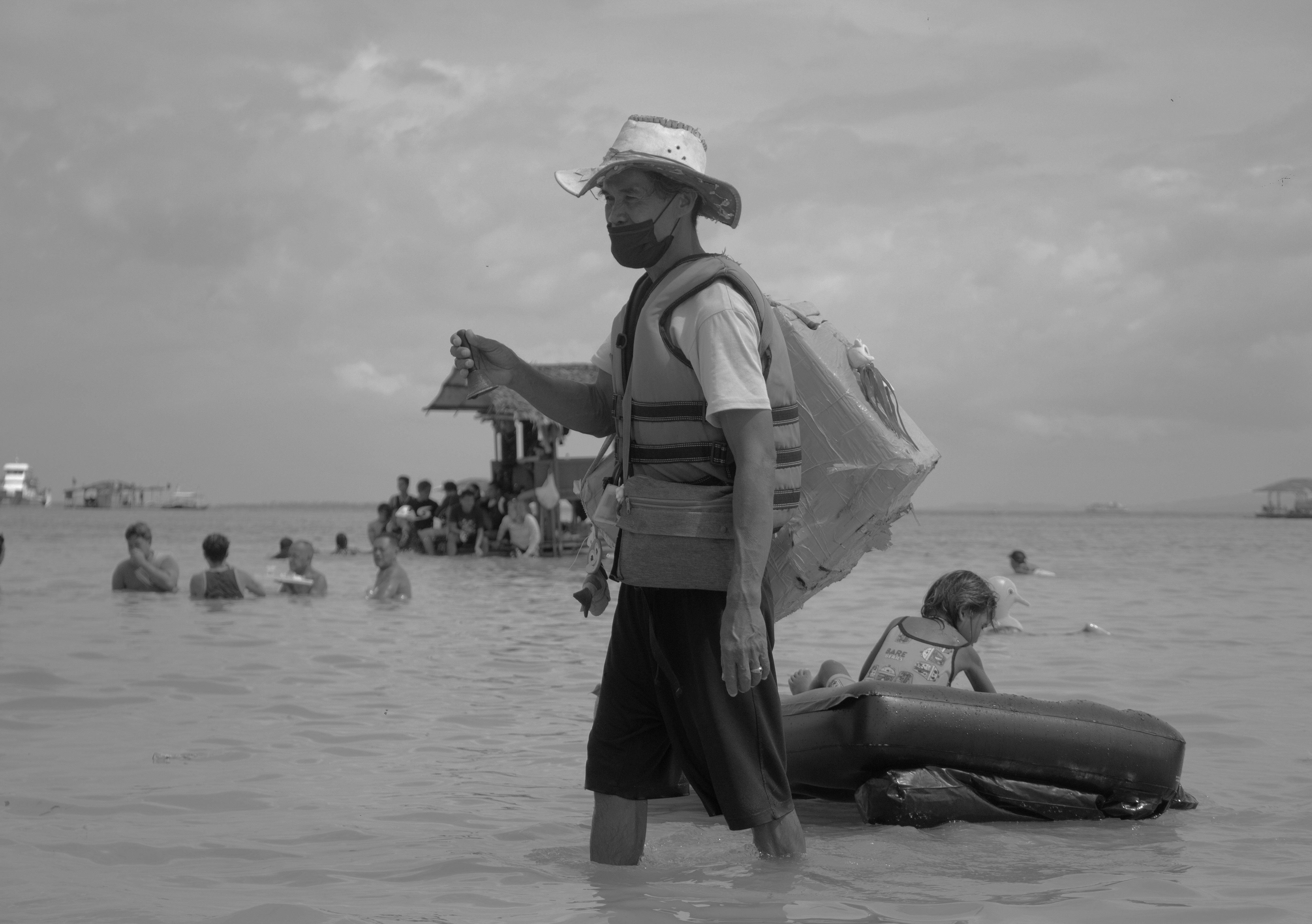 Man in Life Jacket Wading in Sea · Free Stock Photo