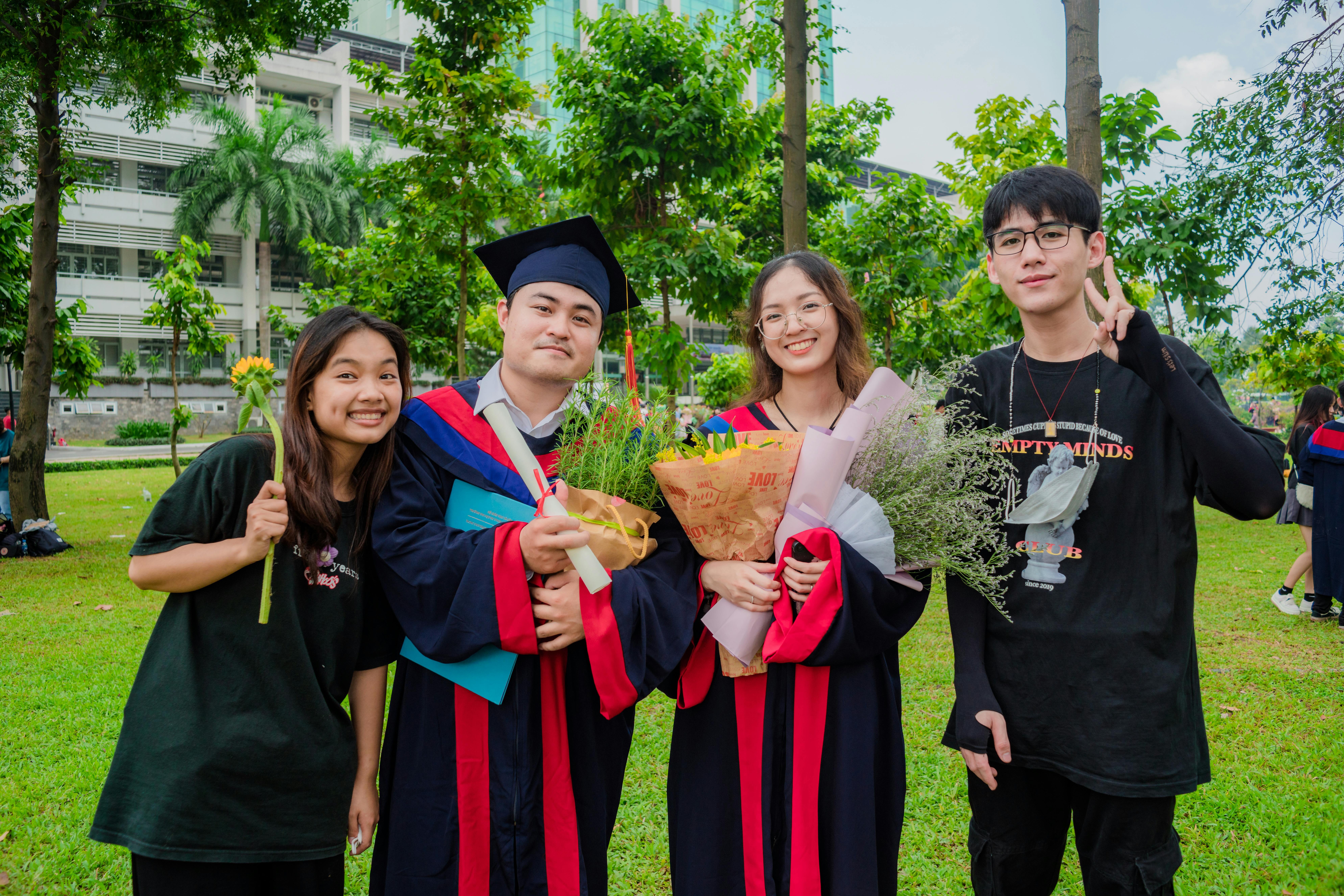 Happy Students Posing with Friends After Graduation · Free Stock Photo