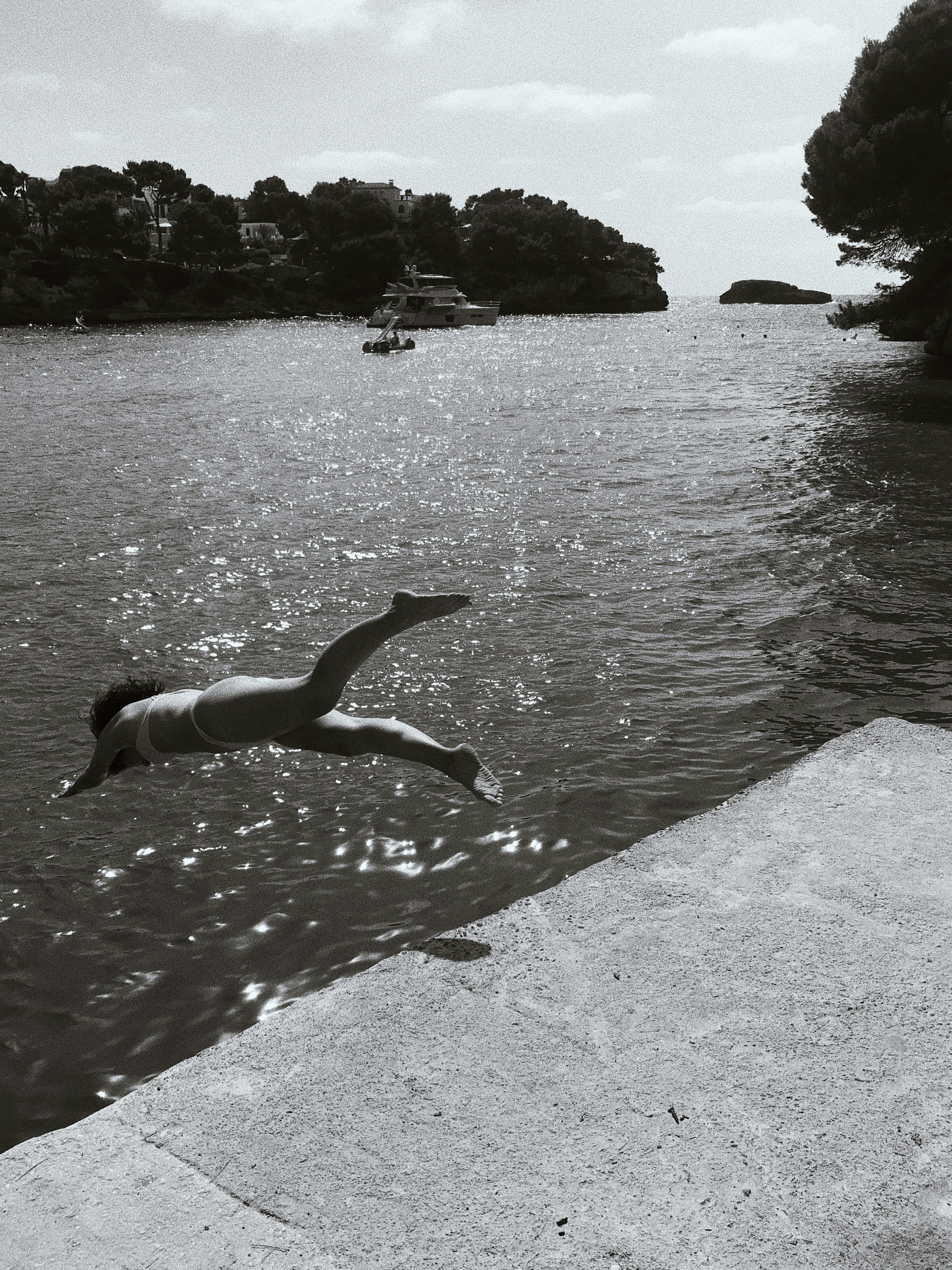 Grayscale Photography Of Woman Diving Into Water · Free Stock Photo