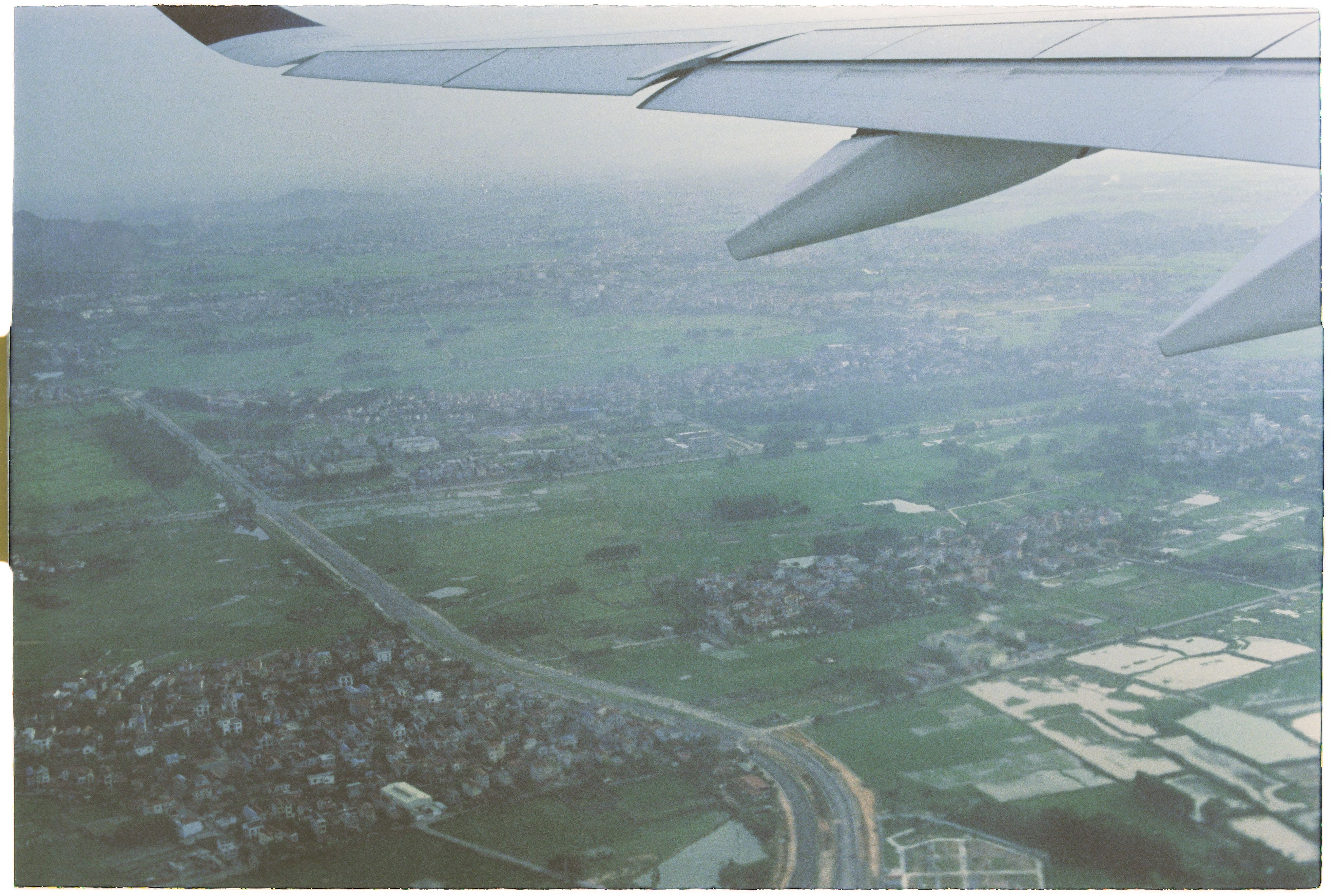 Town and Fields under Wing of Flying Airplane · Free Stock Photo
